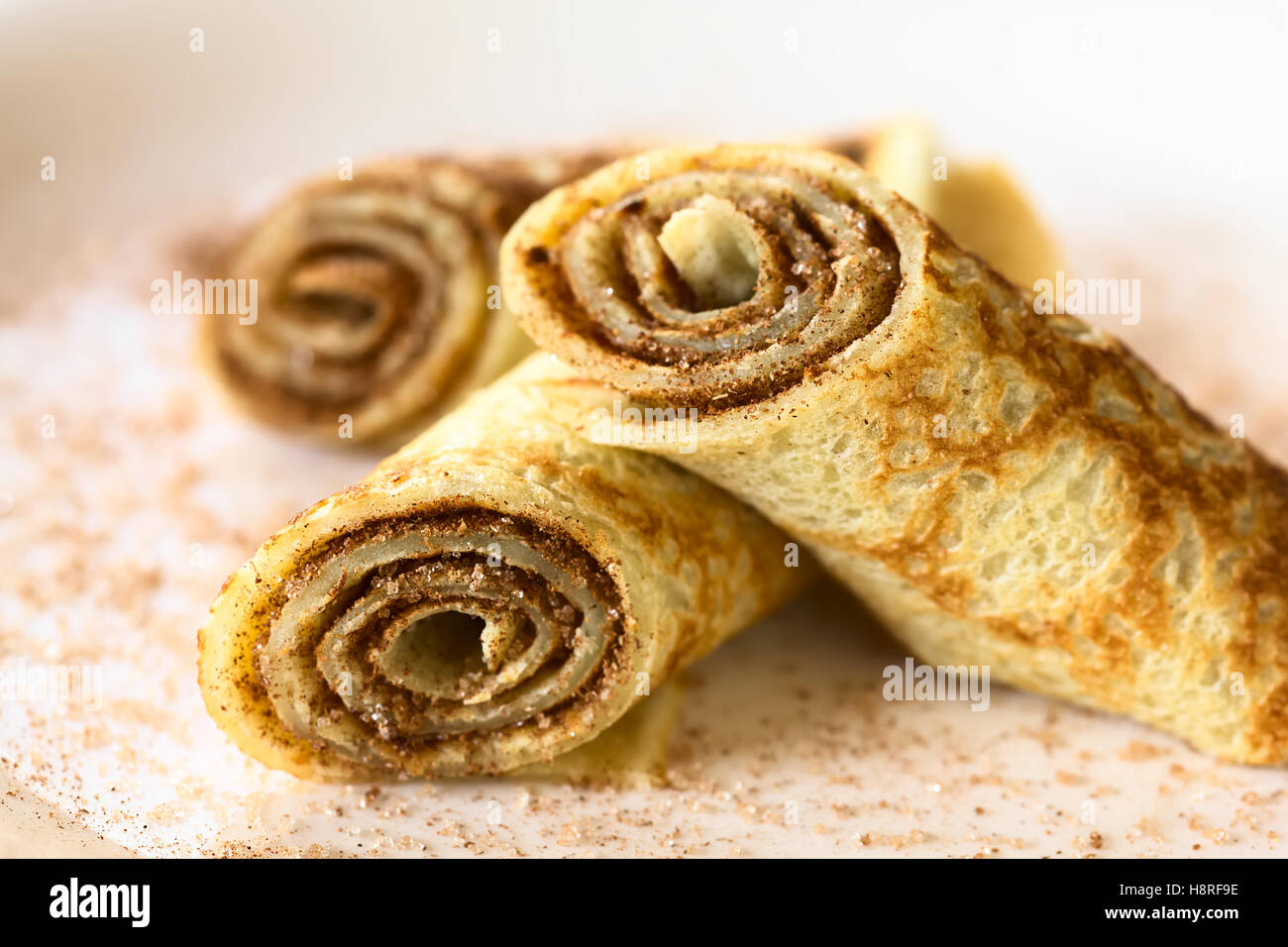 Crepe rolls filled with cinnamon and sugar, photographed with natural ...