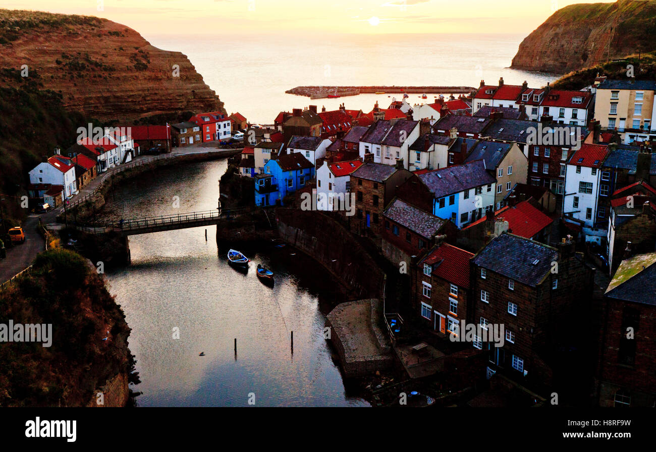 The sun rises as Roxby Beck runs through the old fishing village of ...