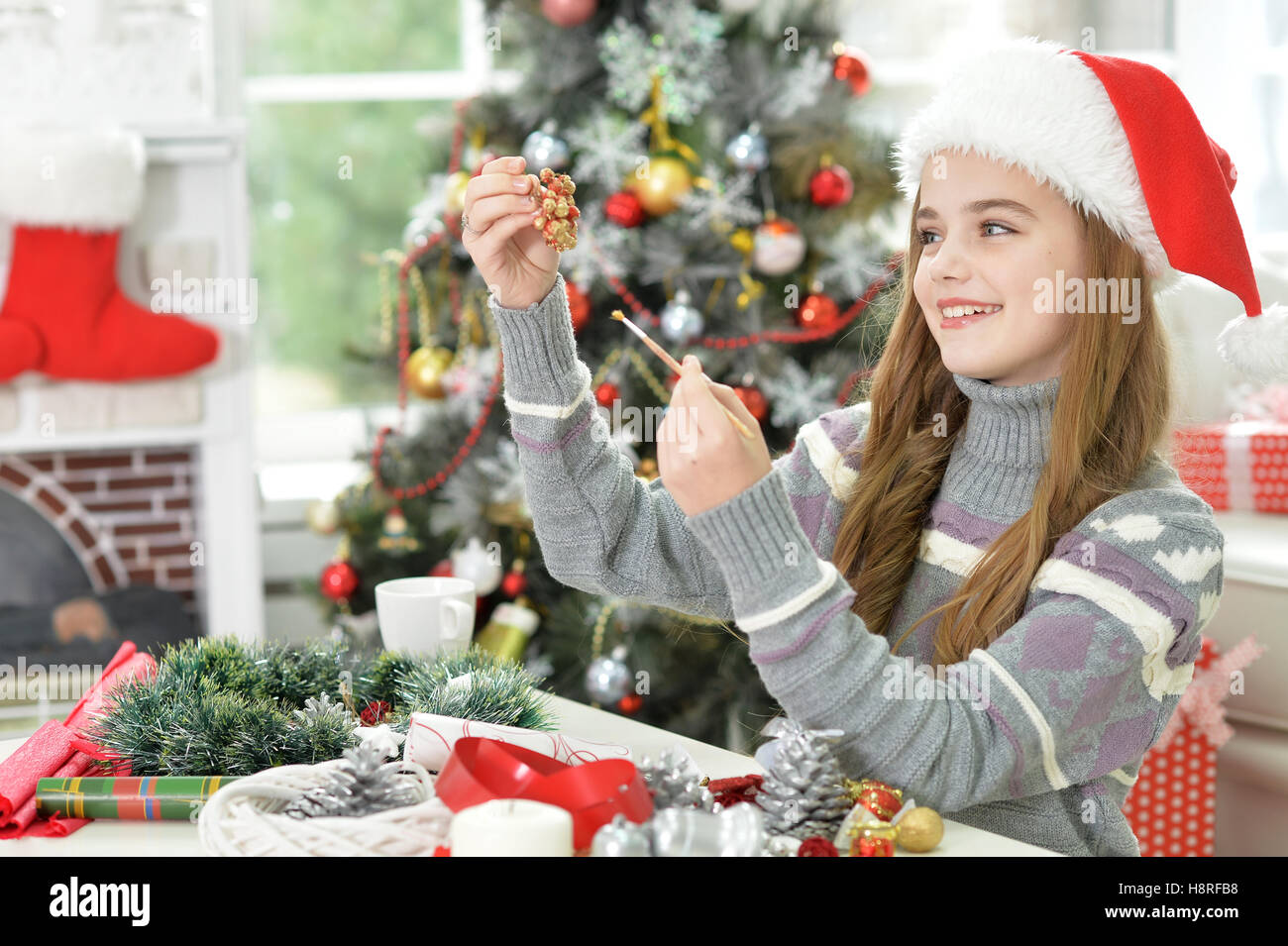 Girl making Christmas decoration Stock Photo - Alamy