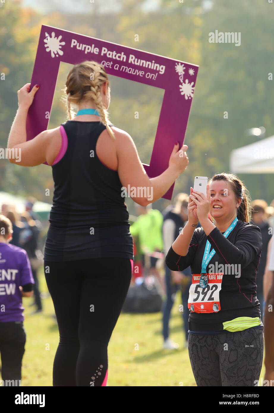 Female runner dressed in running gear holds up an Instagram social ...