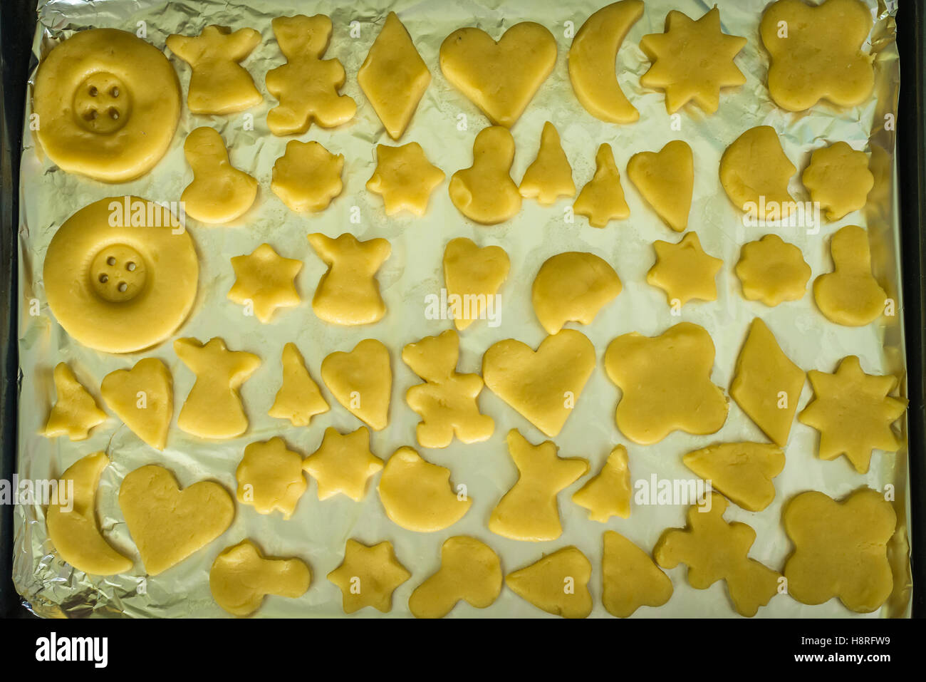 various shapes of dough on the baking tray Stock Photo - Alamy