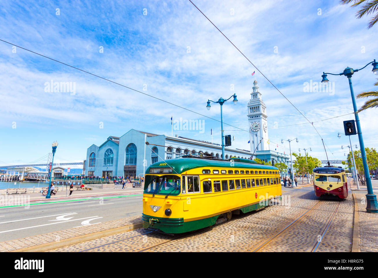 Two vintage F market streetcars pass in front of Ferry Building on ...