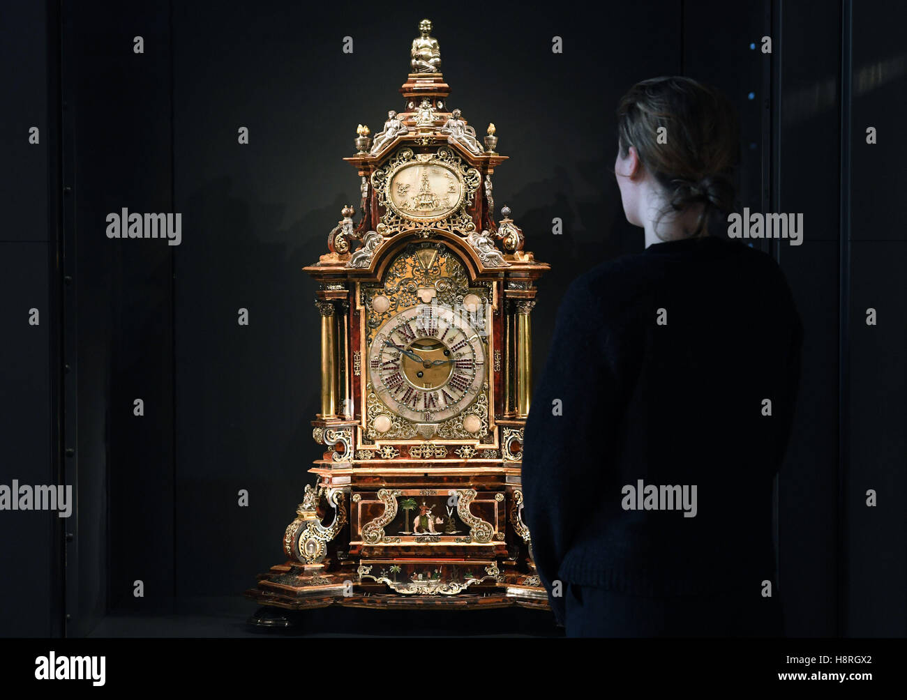 A member of staff looks at a table clock previously owned by former ...