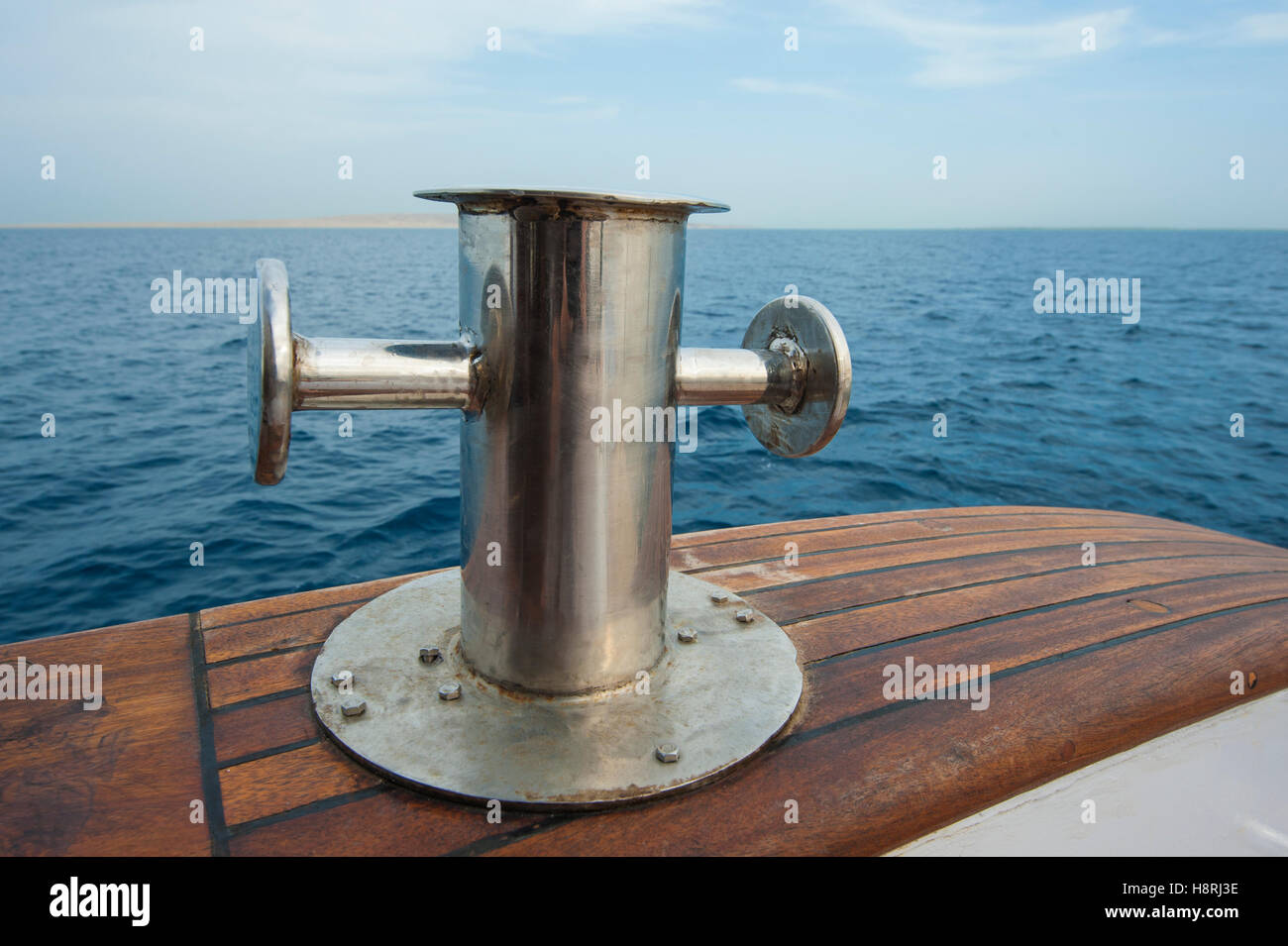 Metal steel capstan post on side teak deck of a luxury motor yacht ...