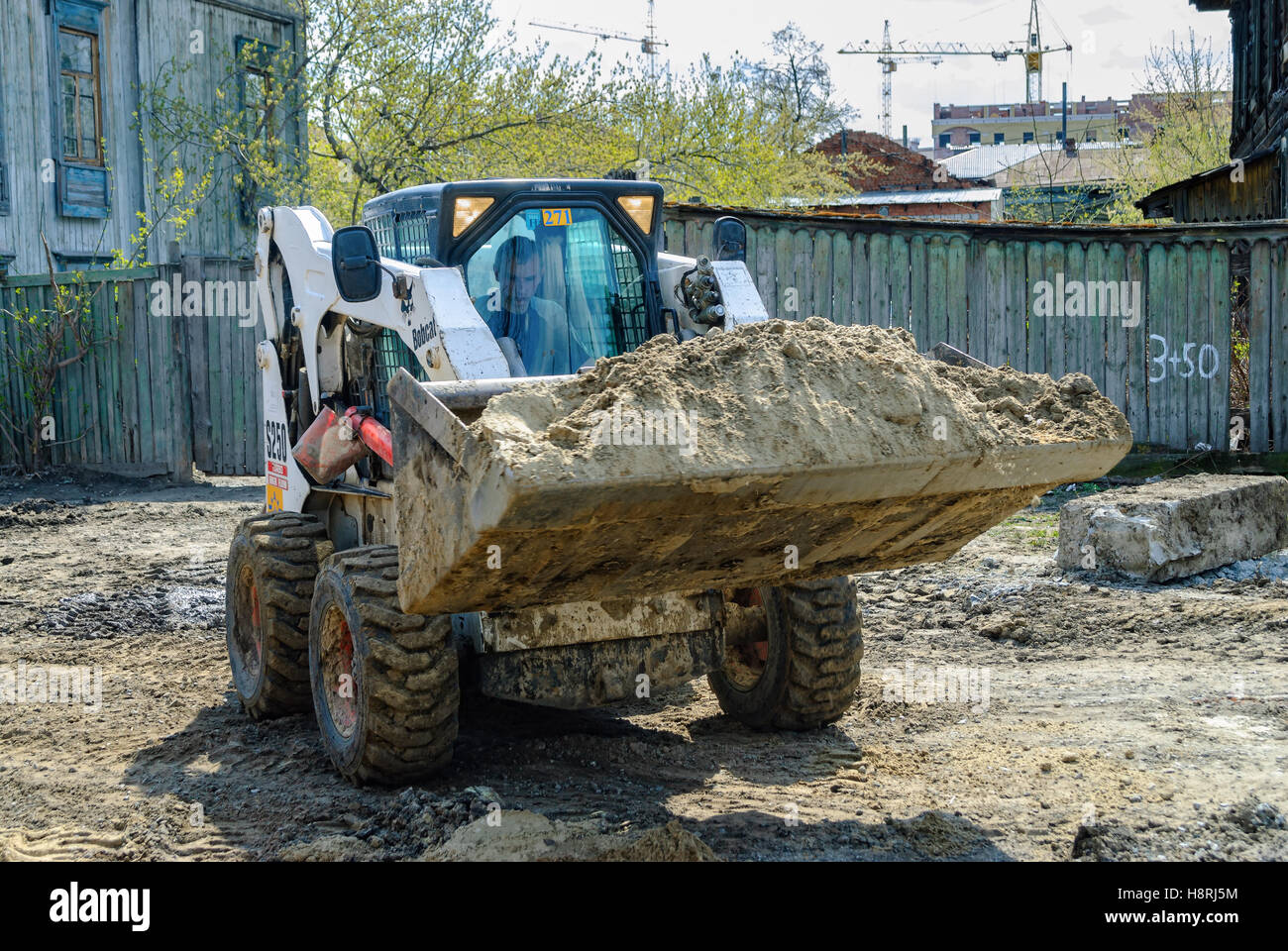 Skid loader on road construction Stock Photo - Alamy