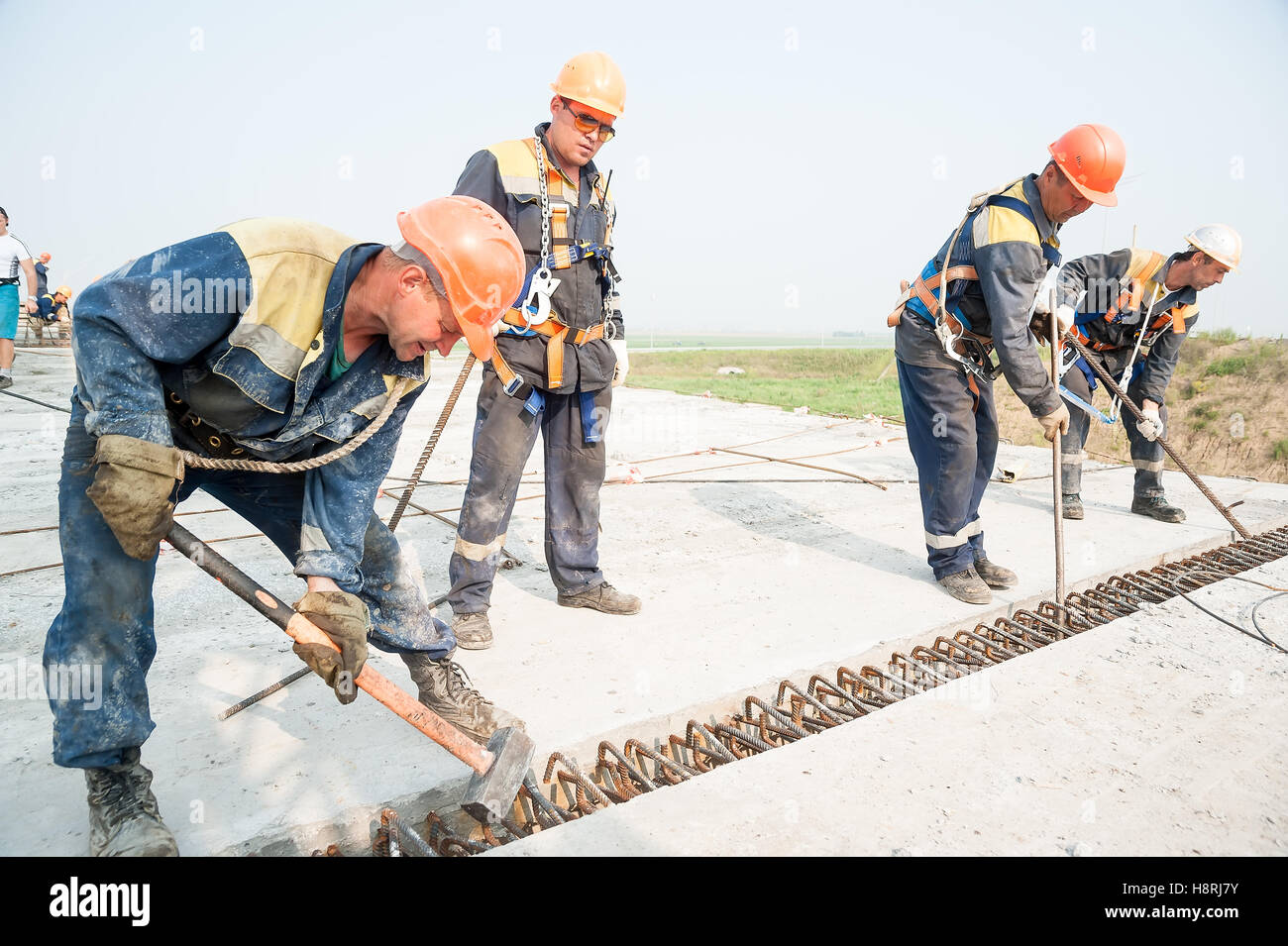 Workers level plates for next filling by concrete Stock Photo - Alamy