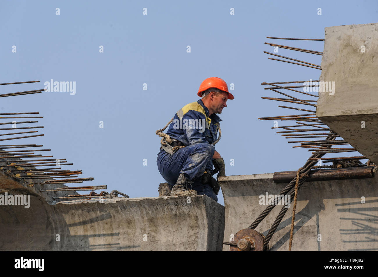 Builder works on bridge construction Stock Photo - Alamy