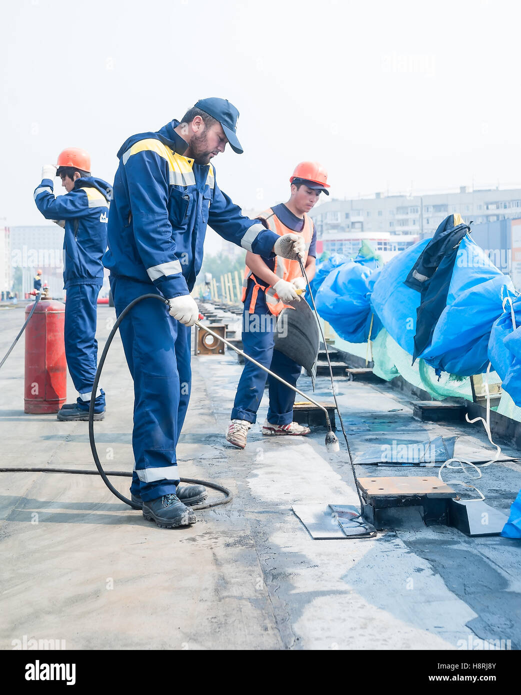Workers waterproofing of seams on bridge Stock Photo - Alamy