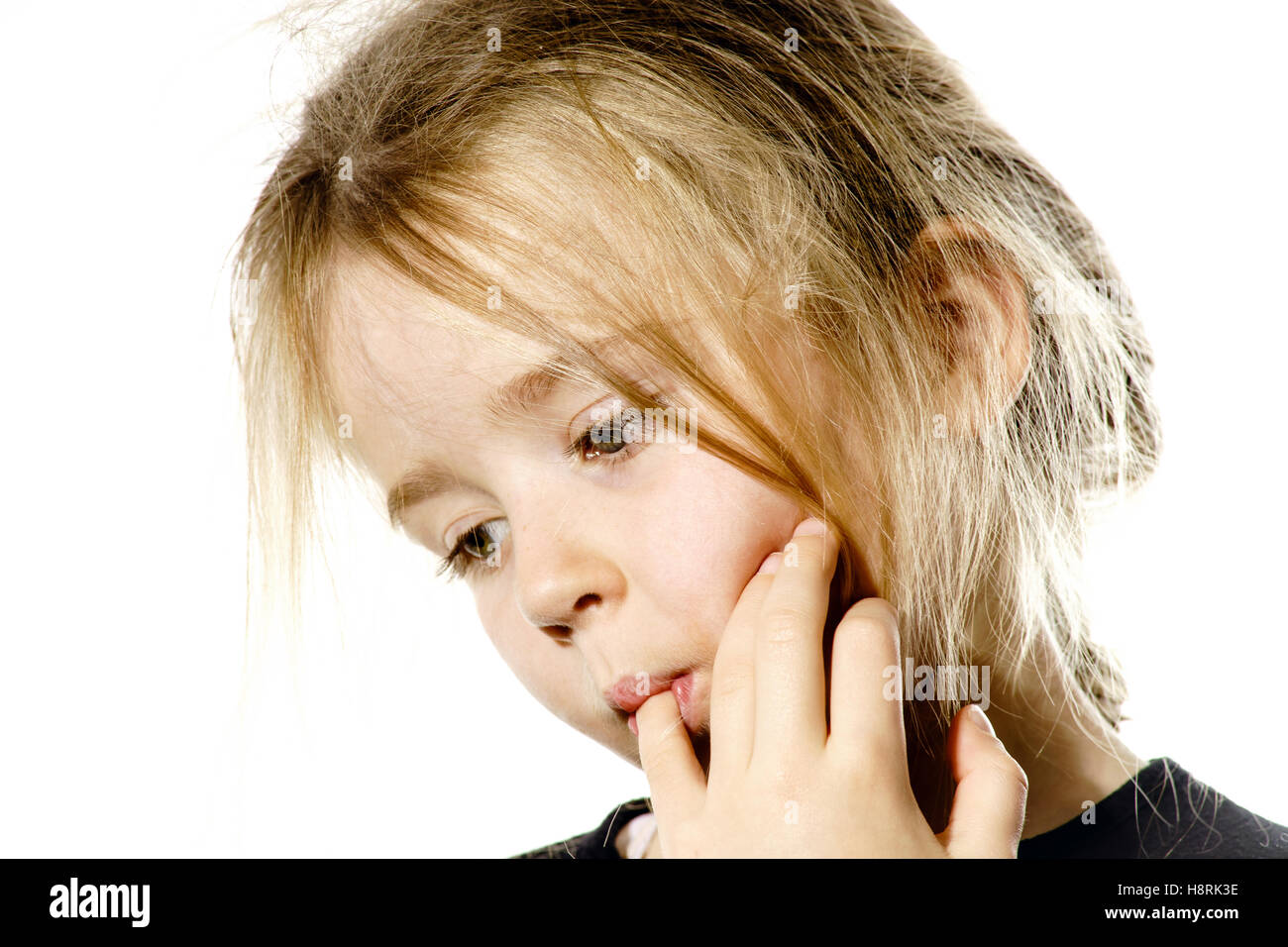 Disheveled preschooler girl with long hair thinking, isolated on white ...