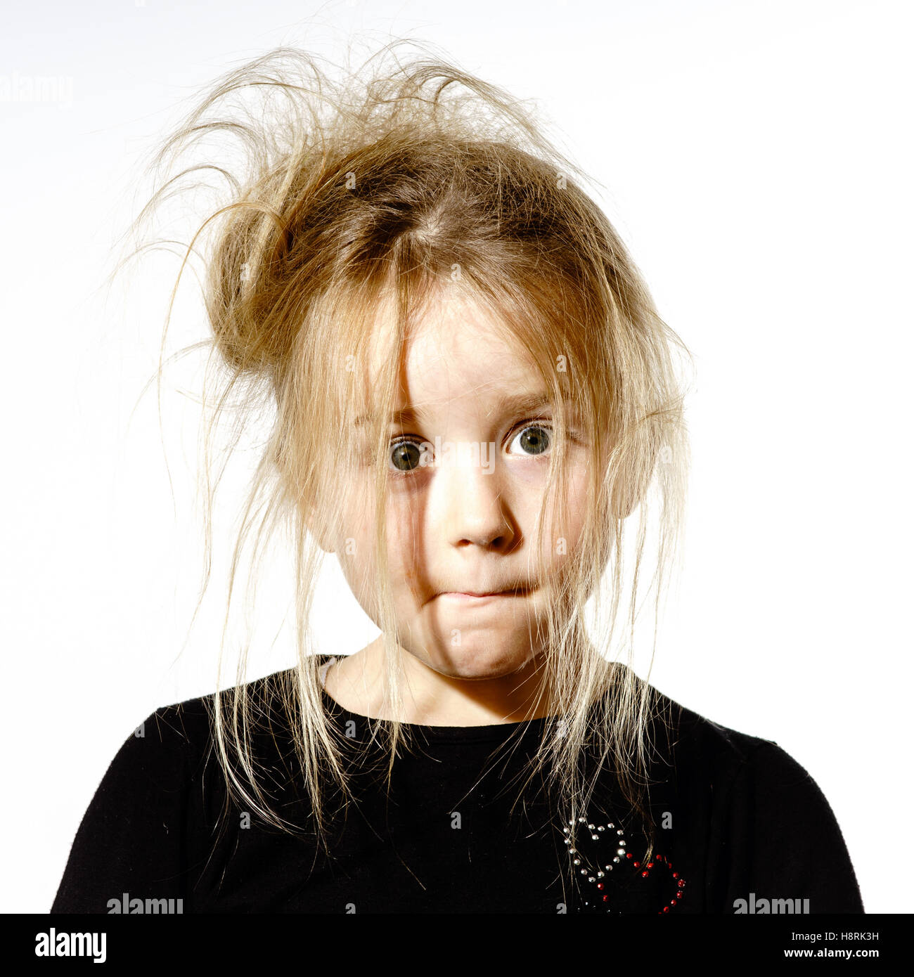 Disheveled preschooler girl with stupid face, isolated on white ...