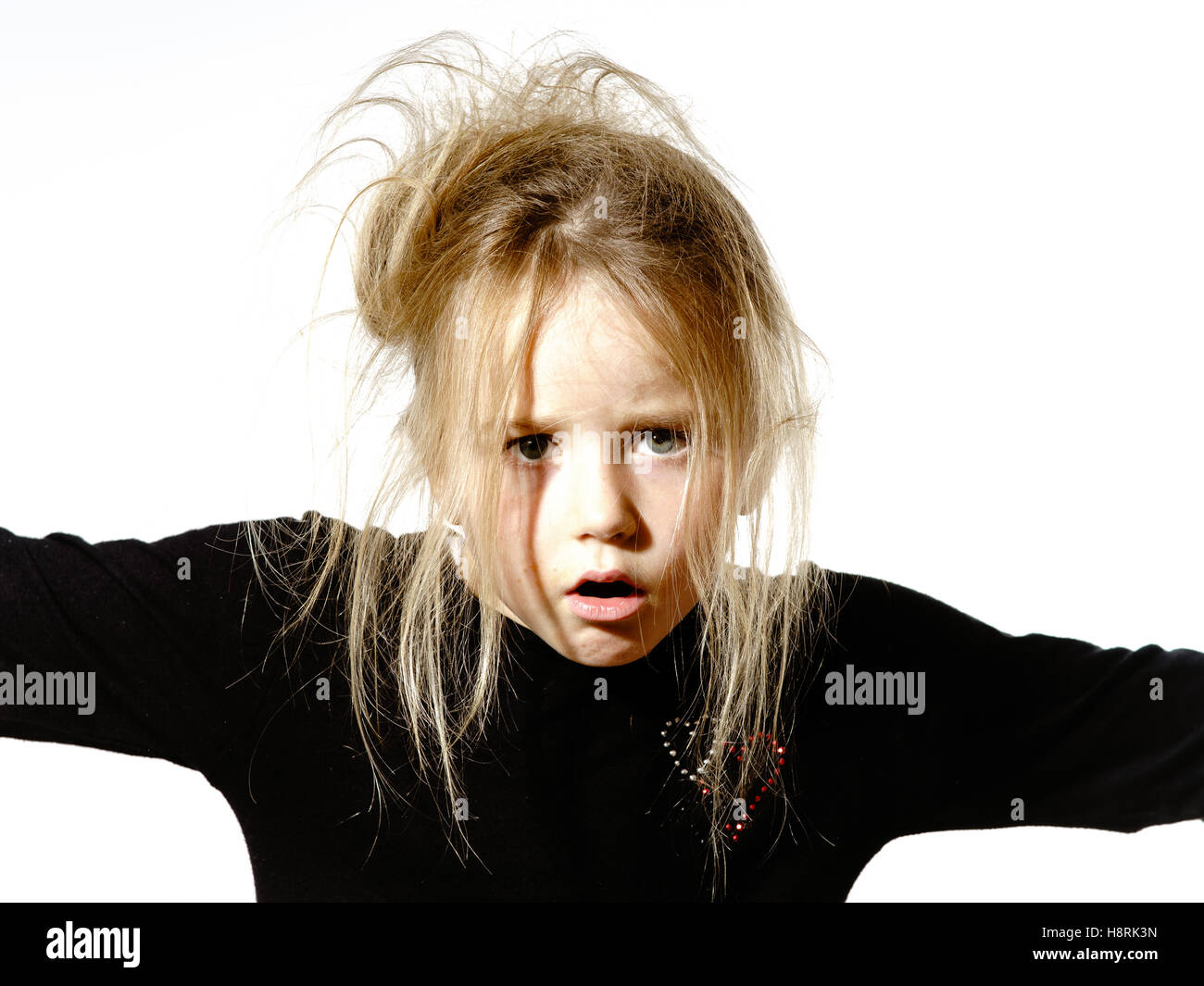 Disheveled preschooler girl with long hair posing, isolated on white ...