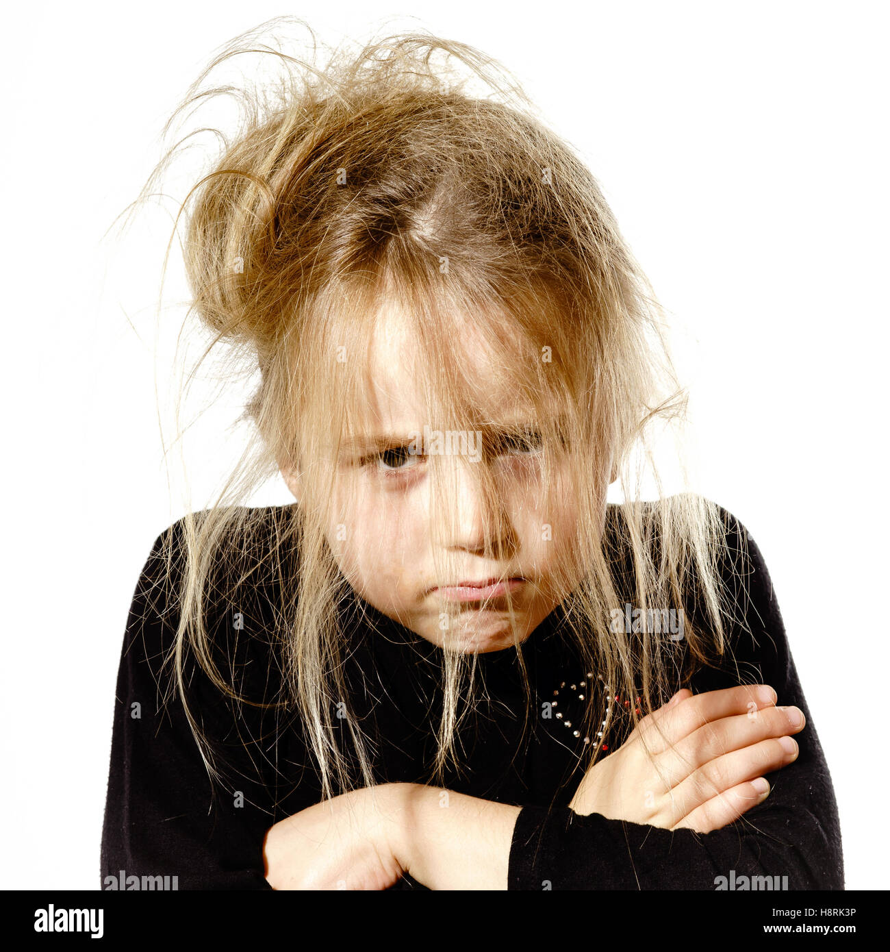 Disheveled preschooler girl with stupid face, isolated on white ...