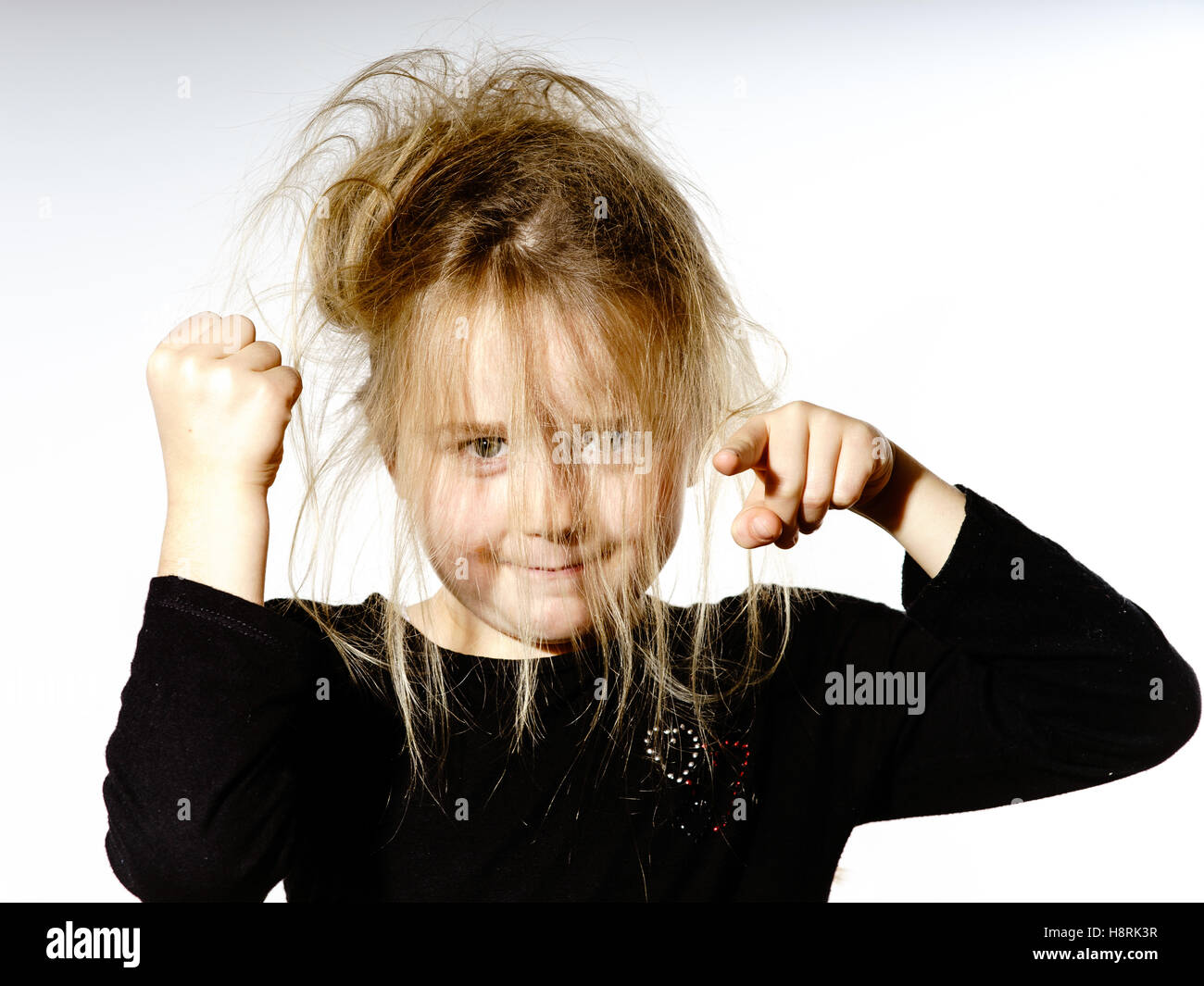 Disheveled preschooler girl with long hair posing, isolated on white ...