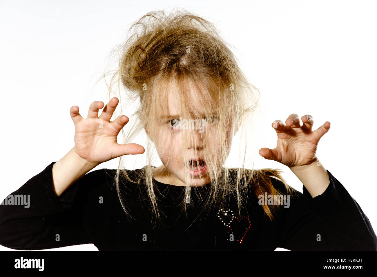 Disheveled preschooler girl with long hair posing, isolated on white ...