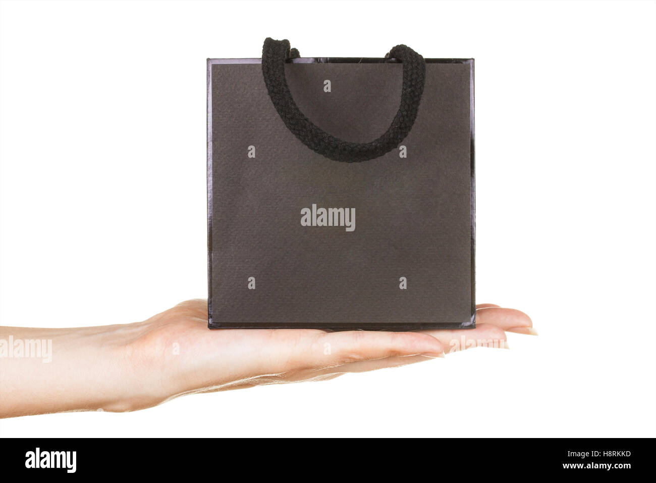Hand with black paper bag on white Stock Photo - Alamy