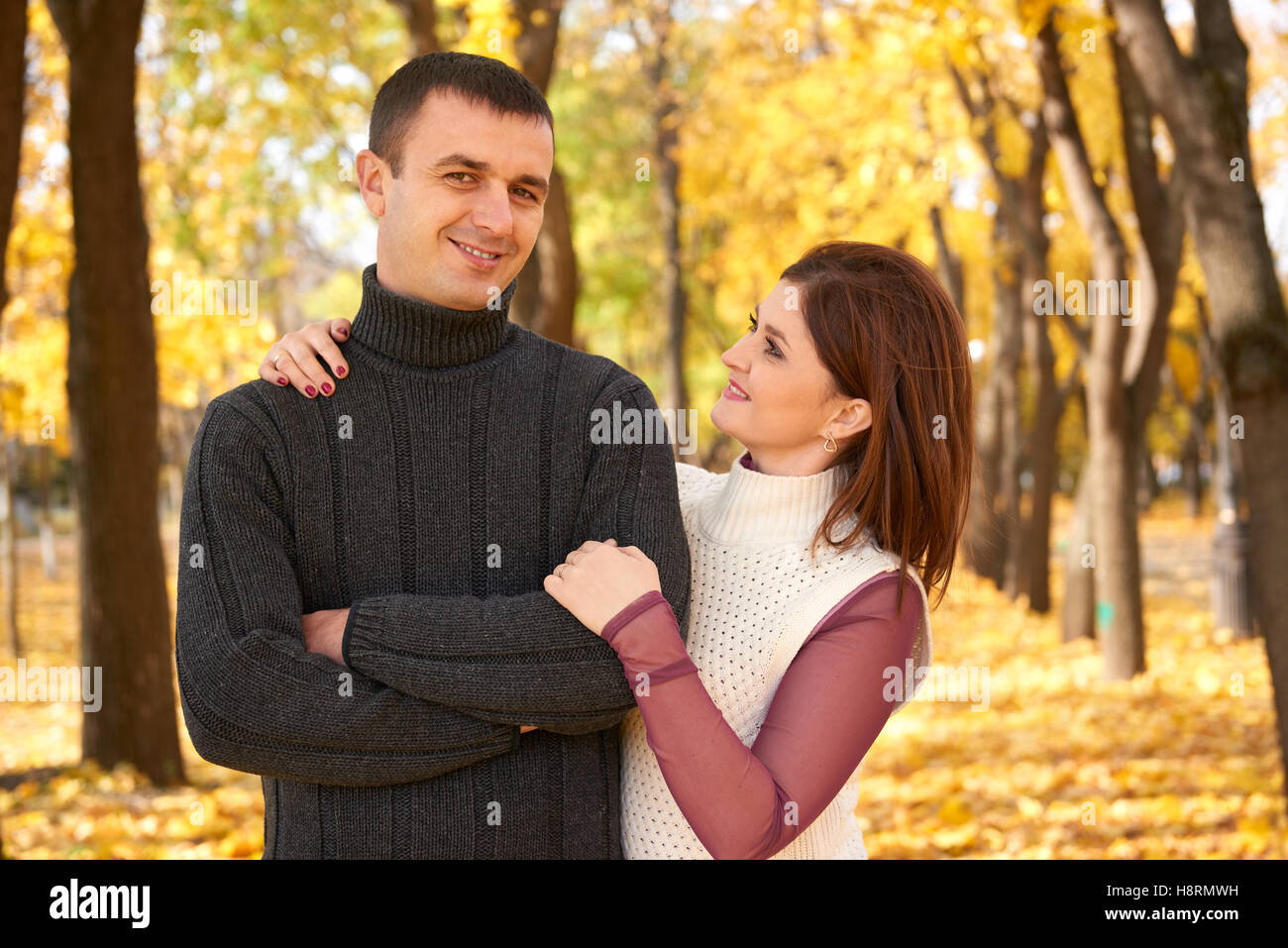 romantic people, happy adult couple embrace in autumn city park, trees ...