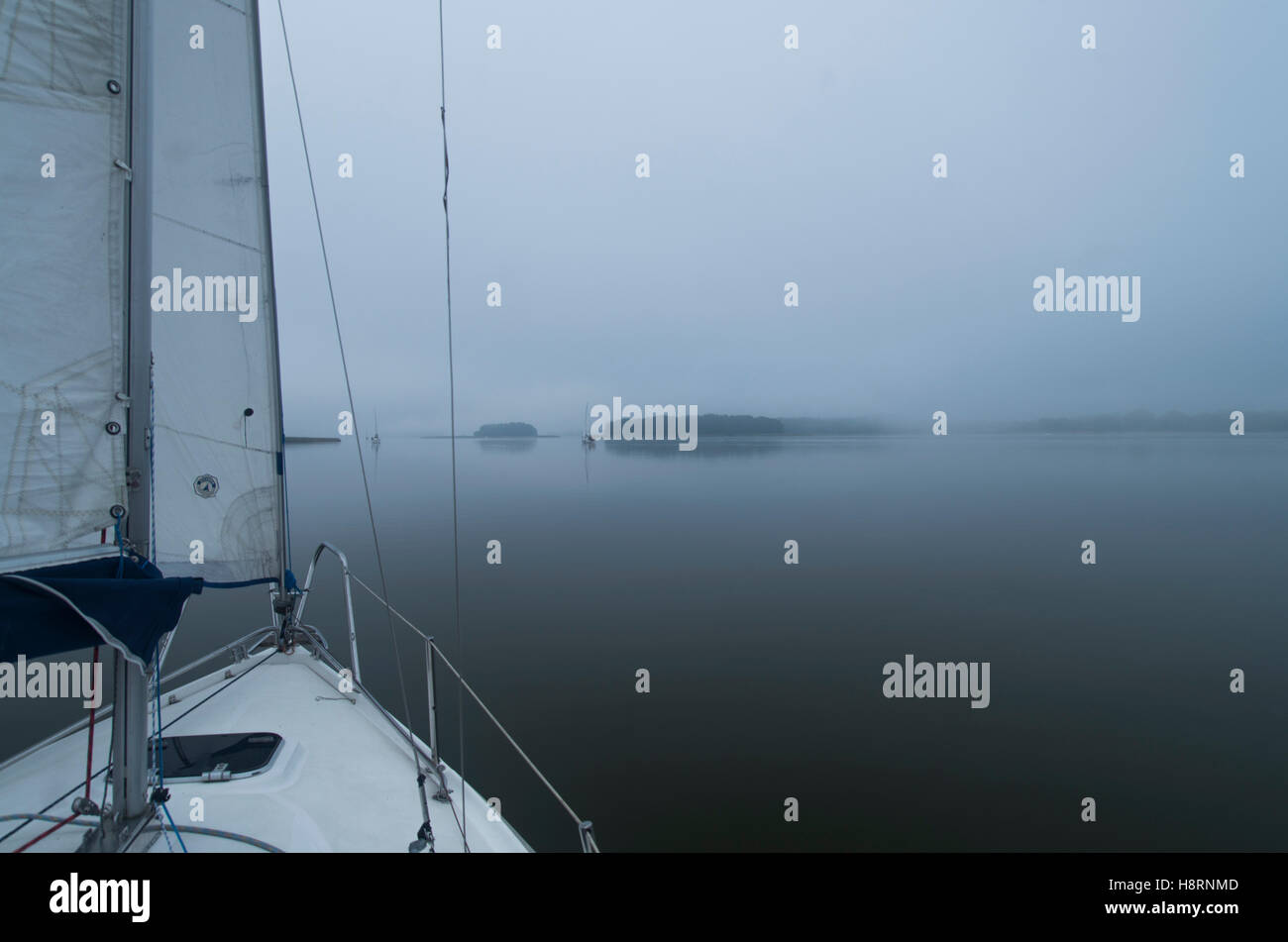 Sailboat sailing in mist lake hi-res stock photography and images - Alamy