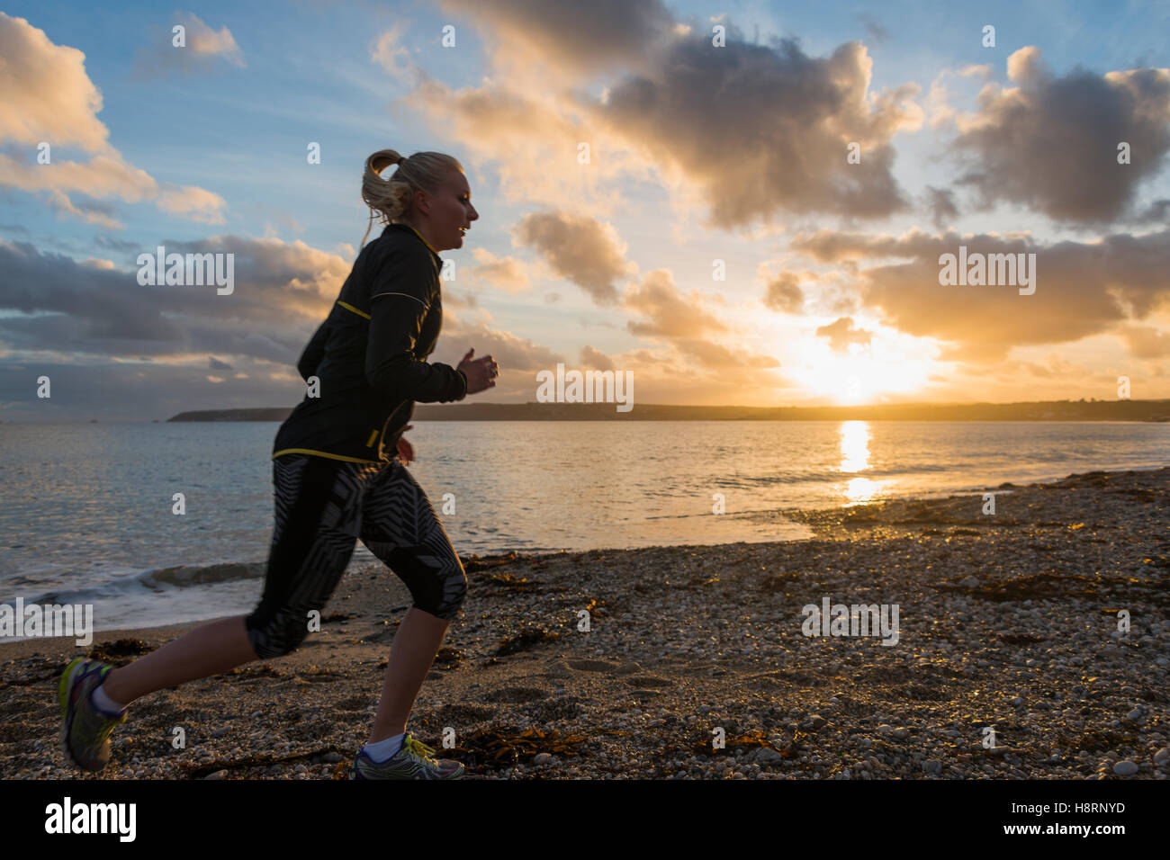 Female runner at sunset hi-res stock photography and images - Alamy