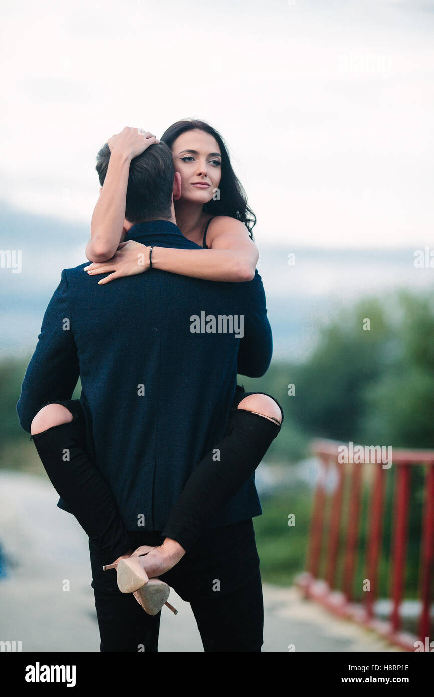 man holding his girlfriend on hands Stock Photo - Alamy