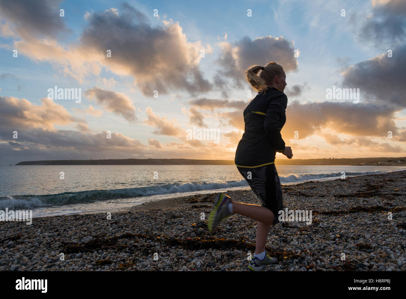 Female jogger at the beach hi-res stock photography and images - Alamy