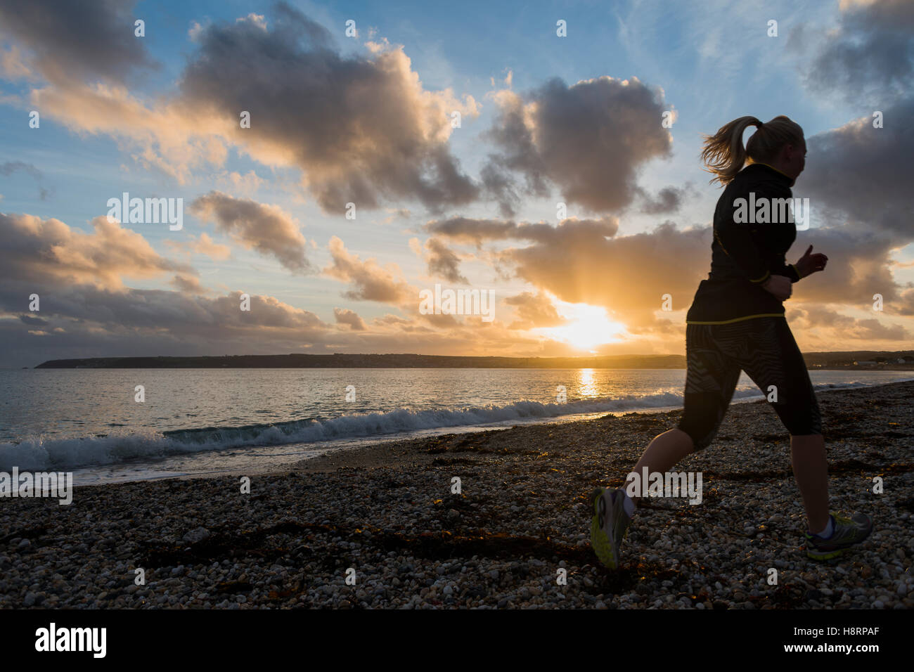 Female jogger at the beach hi-res stock photography and images - Alamy