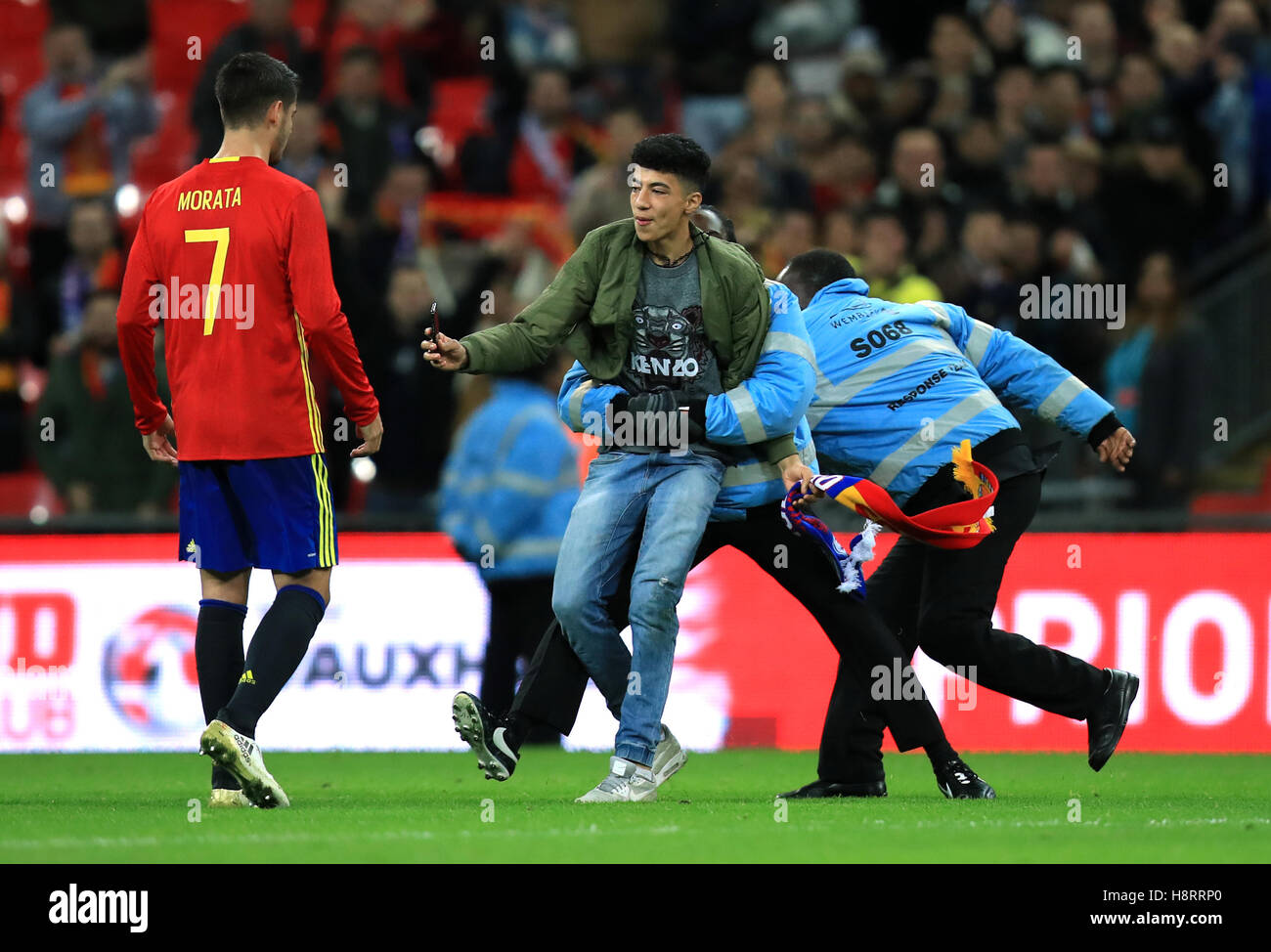 A pitch invader runs on after the International Friendly at Wembley ...