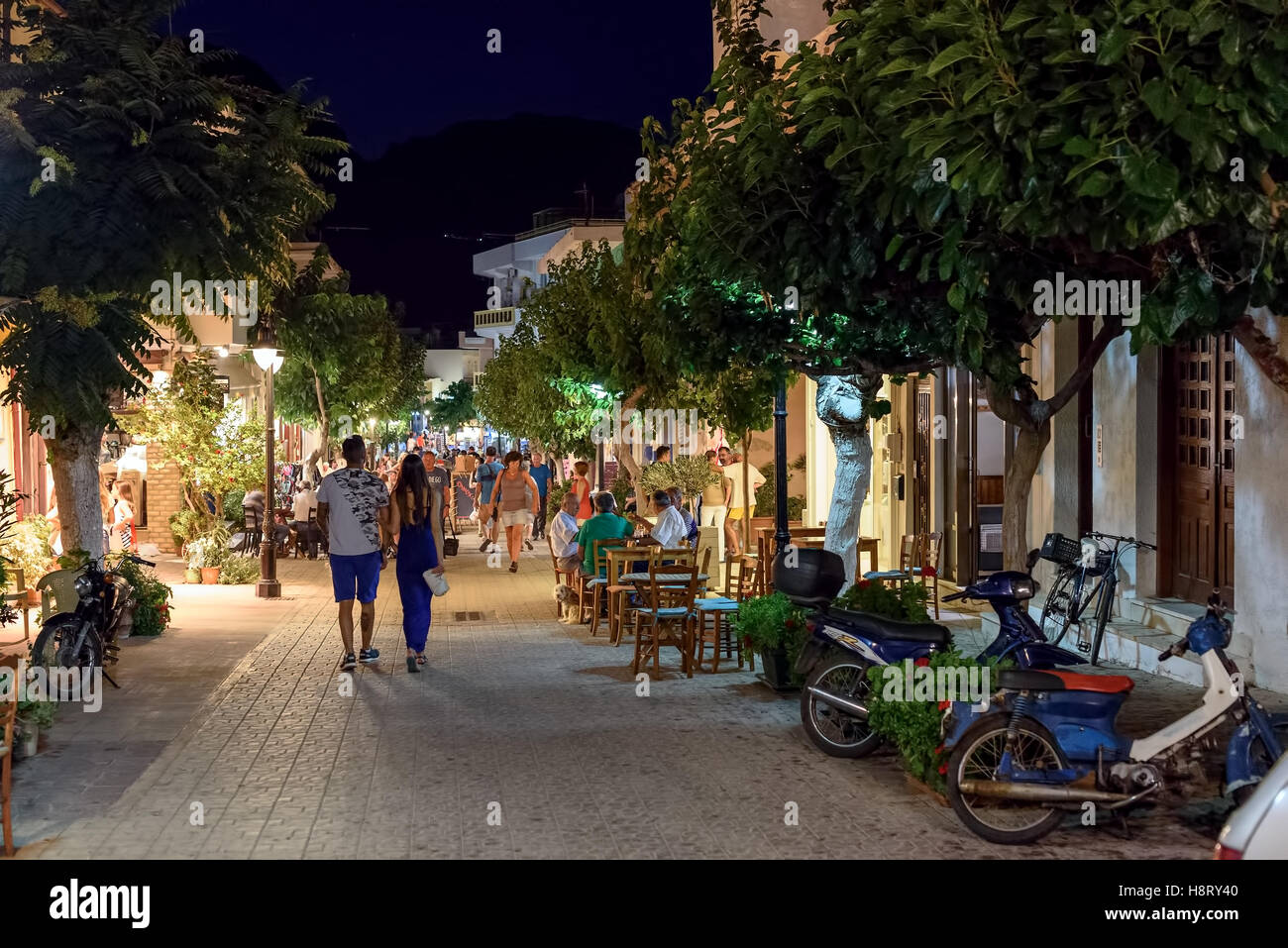 People walking at night street of Paleochora town on Crete island ...