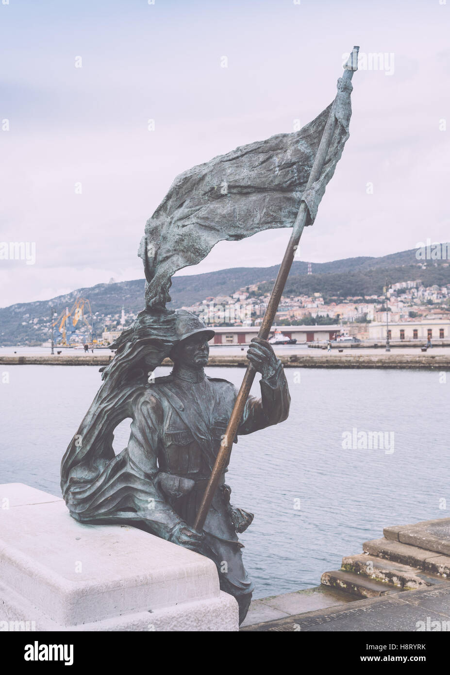 Bronze of Bersagliere soldier statue with flag in Trieste. Sculpture ...