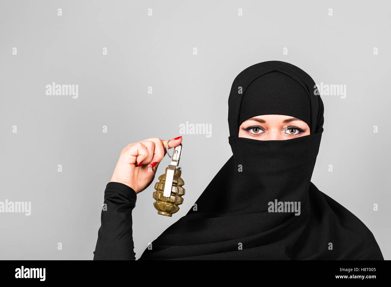 Hand grenade in a Eastern woman's hand. The concept of terrorism and ...