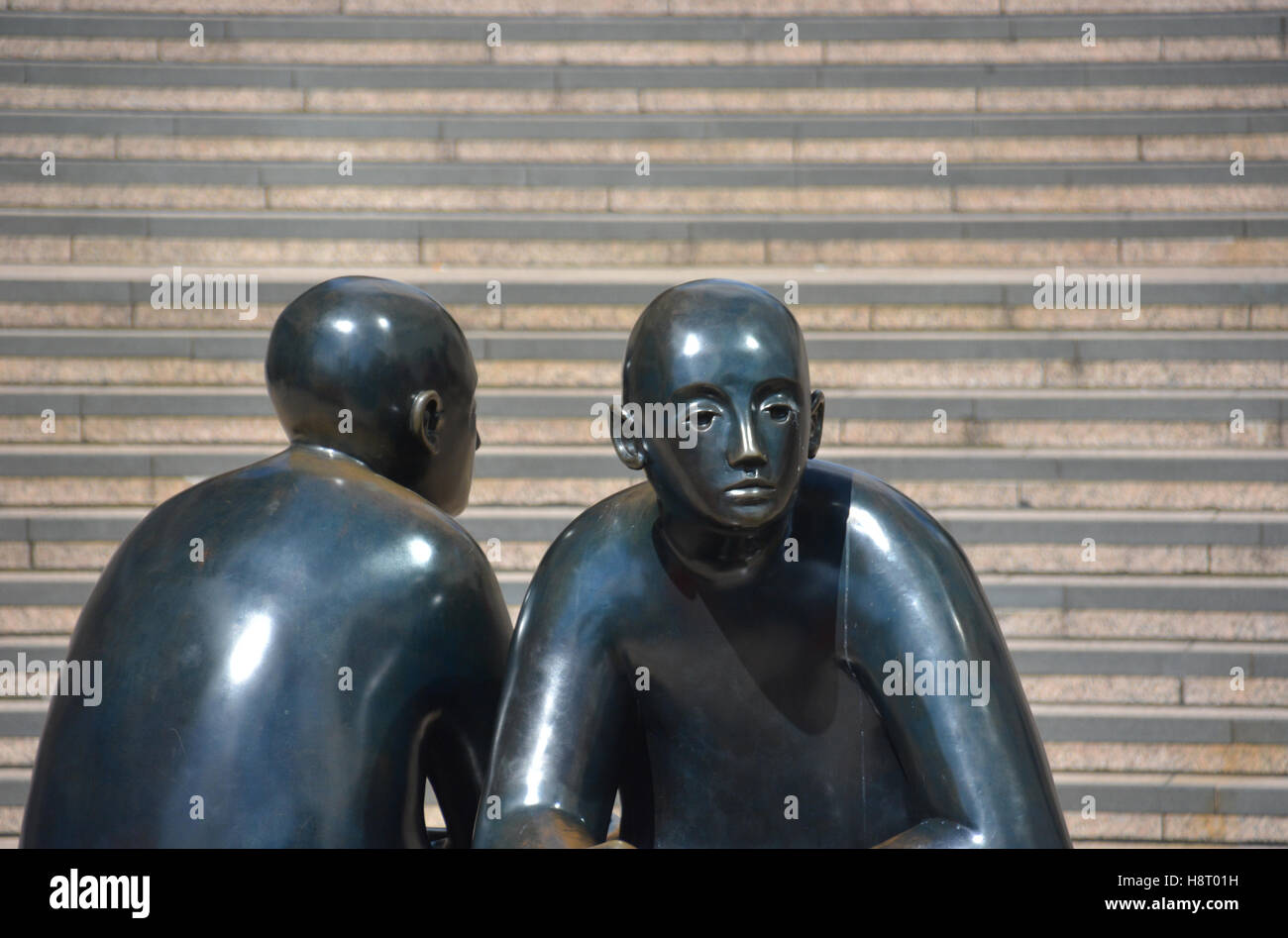 Statue of two figures with steps as background taken in Docklands ...