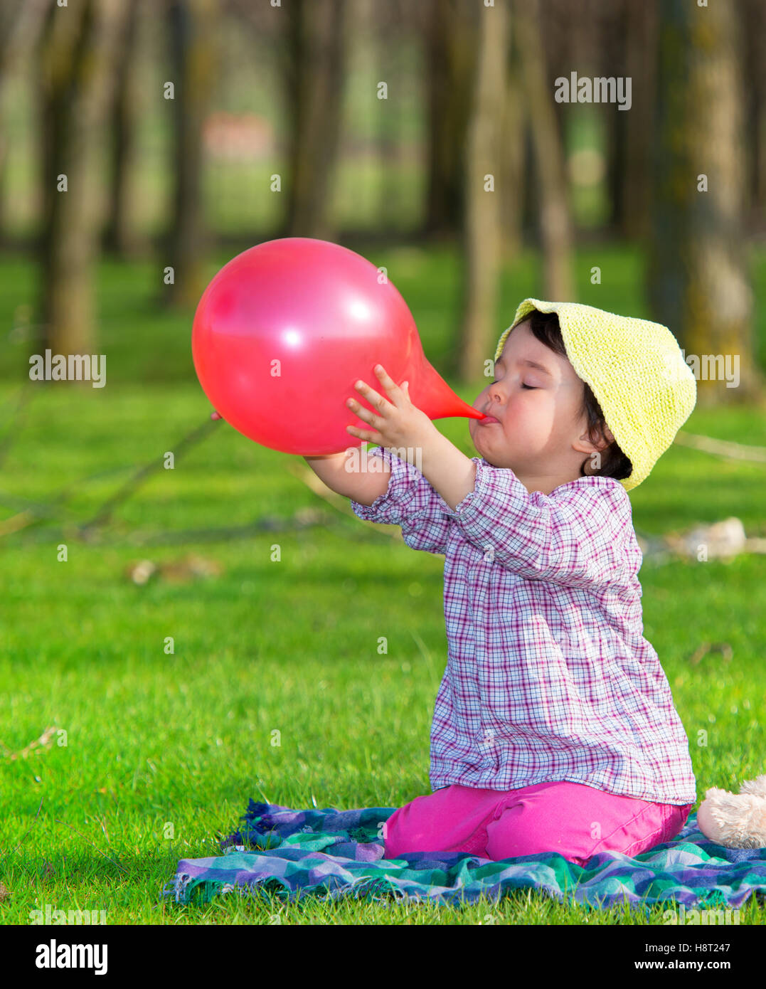 Girl blowing up balloon outdoors hi-res stock photography and images ...