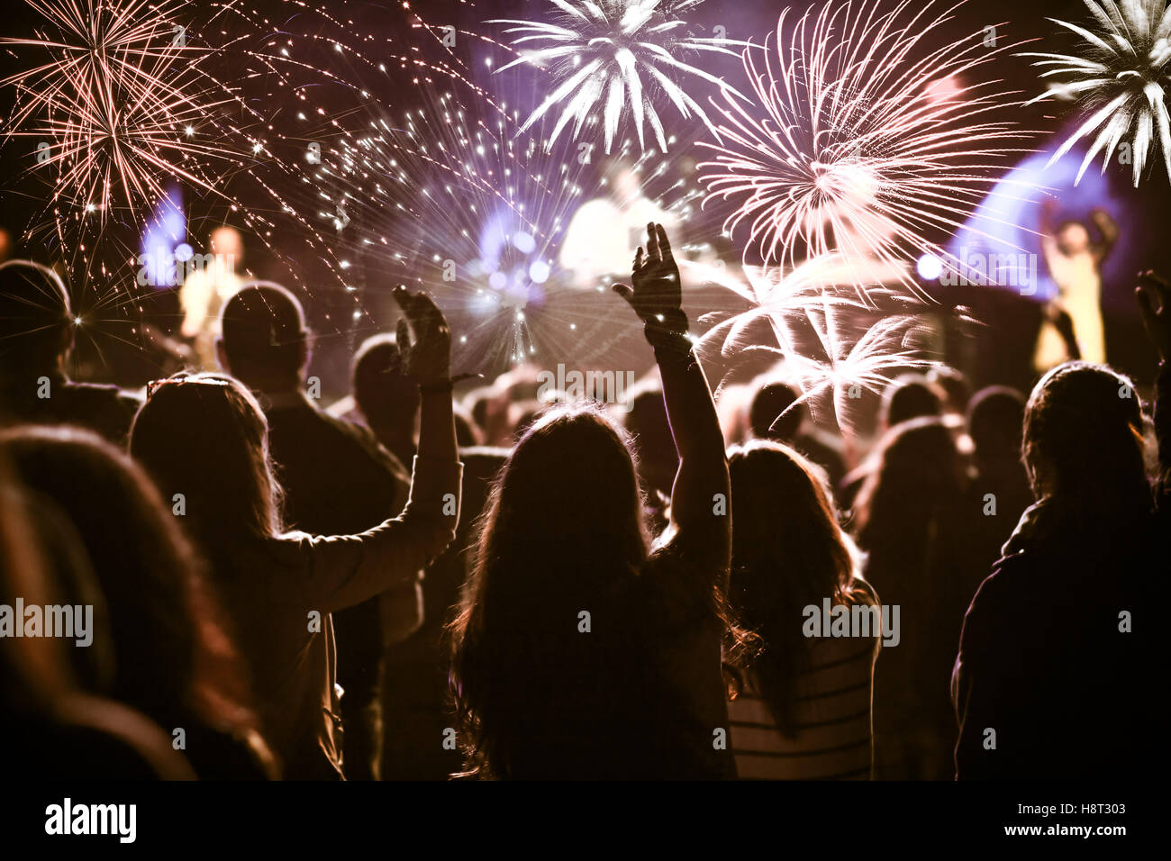 cheering crowd and fireworks - New Year celebration concept Stock Photo ...