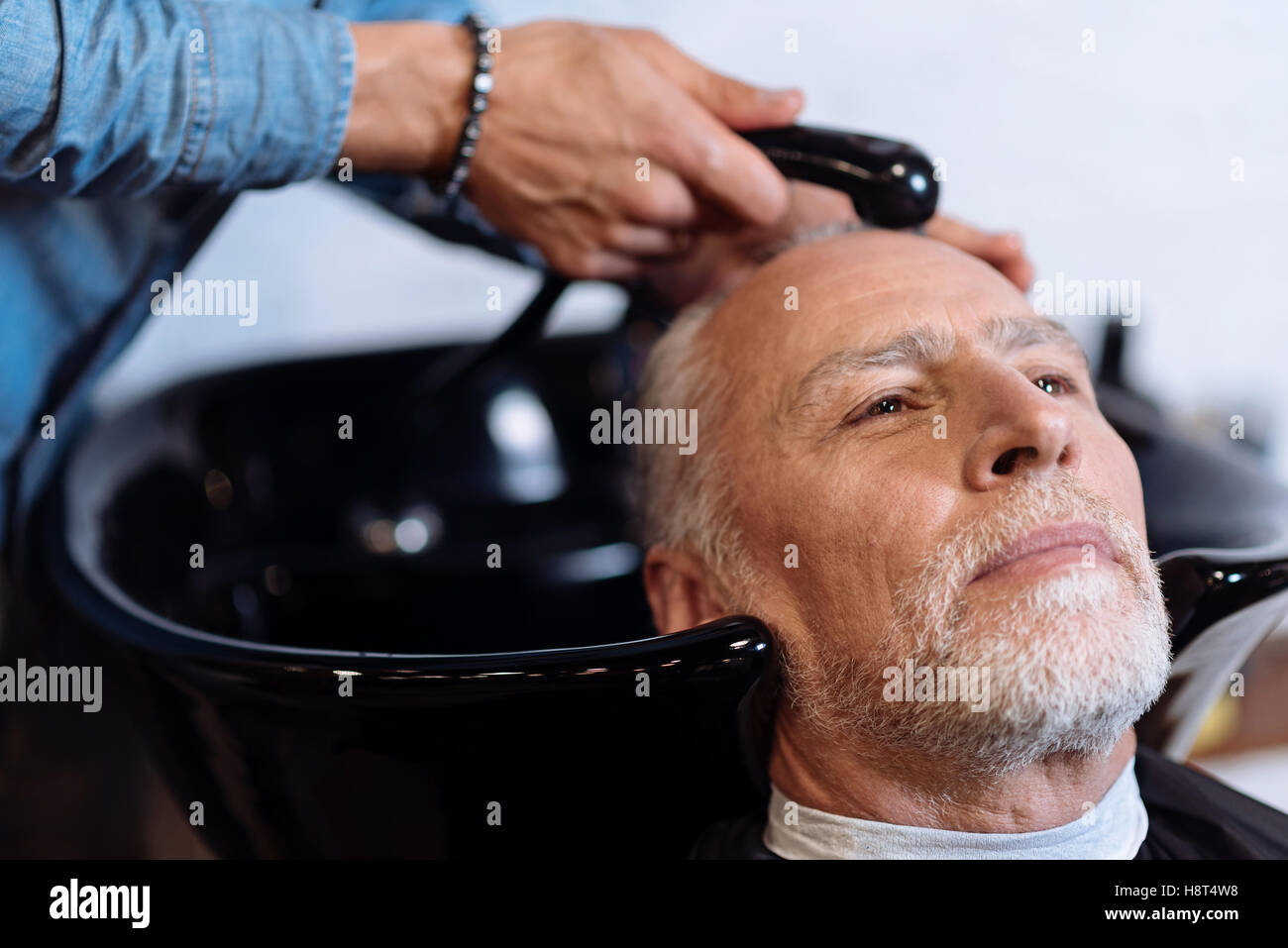 Old man during washing his hair in barber shop Stock Photo - Alamy