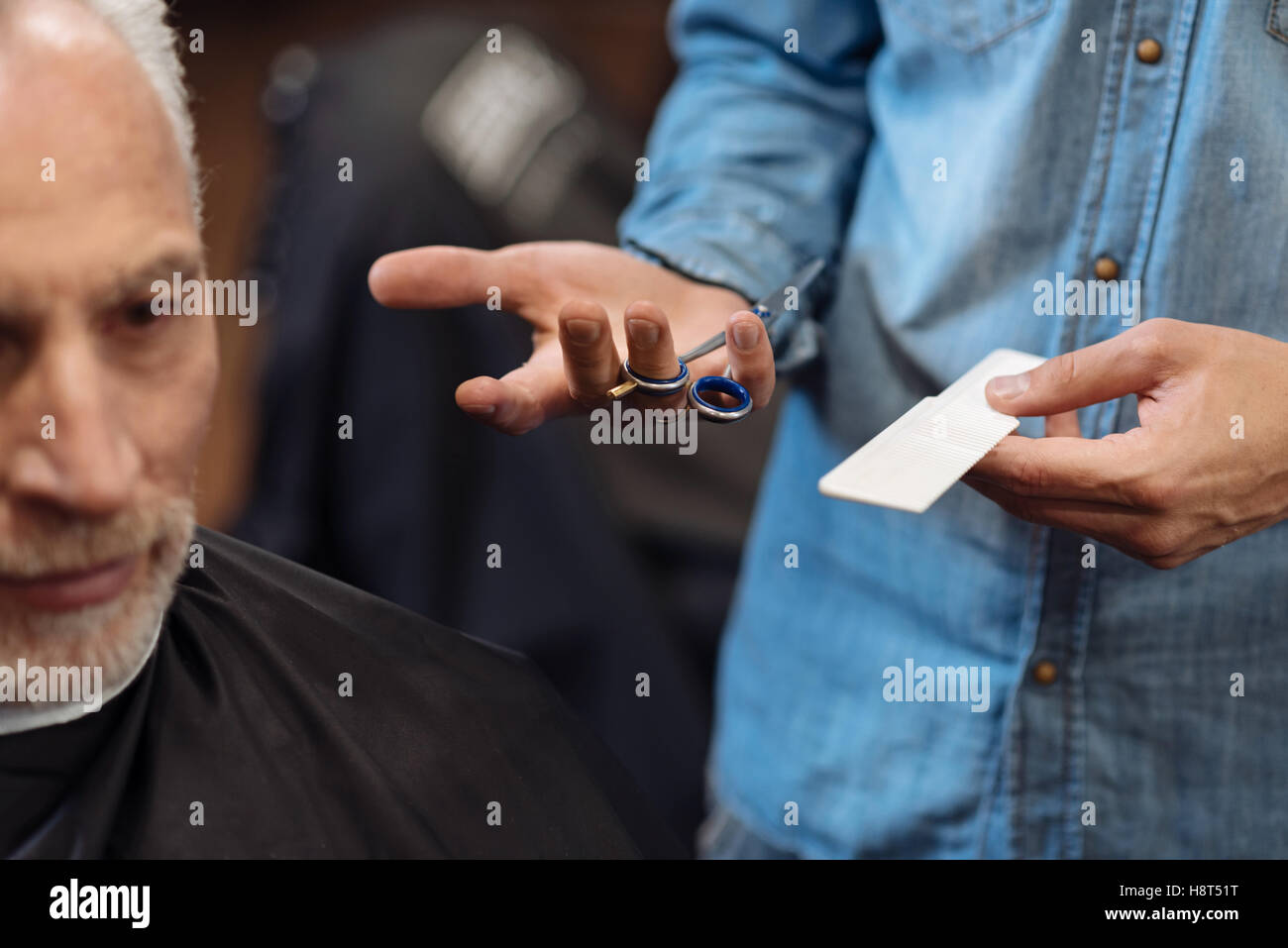 Close up of male barber holding scissors and comb Stock Photo - Alamy