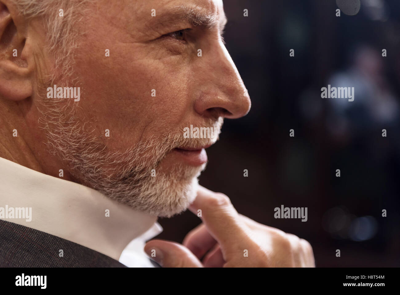 Close-up of senior man with fingers on chin Stock Photo - Alamy