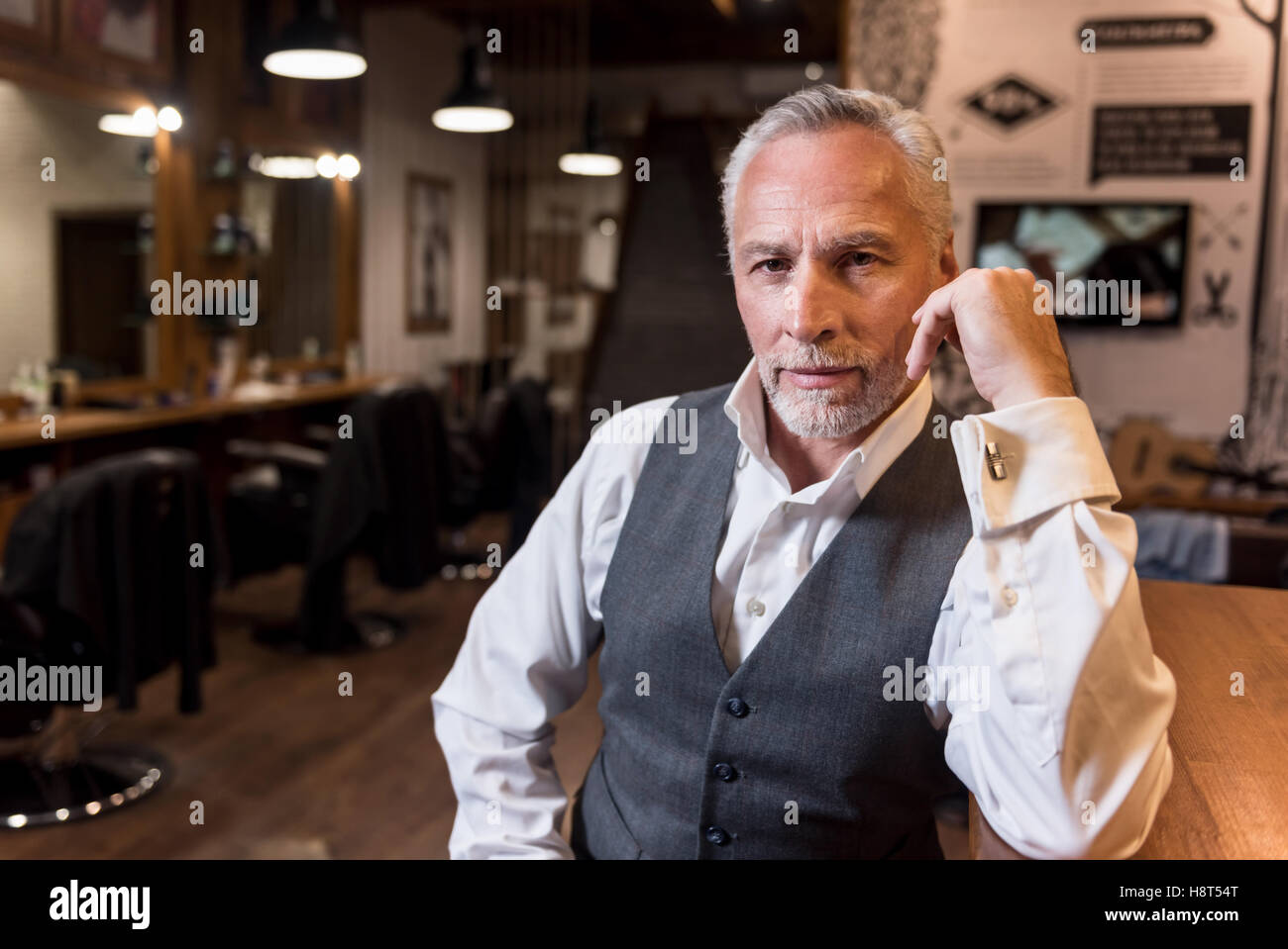 Old man sitting at bar counter and looking forward Stock Photo - Alamy