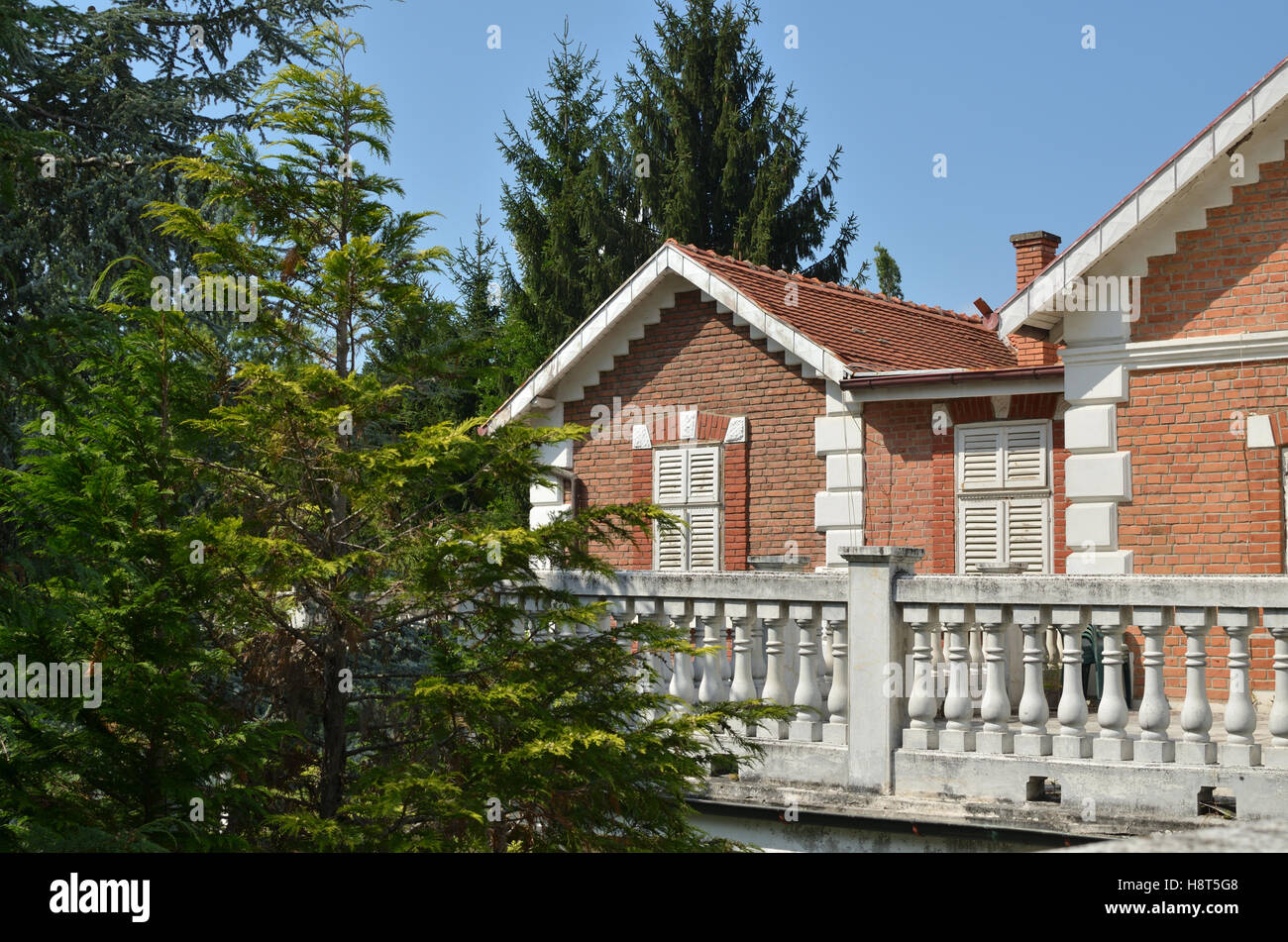 Residential home building of red brick with white wooden blinds ...