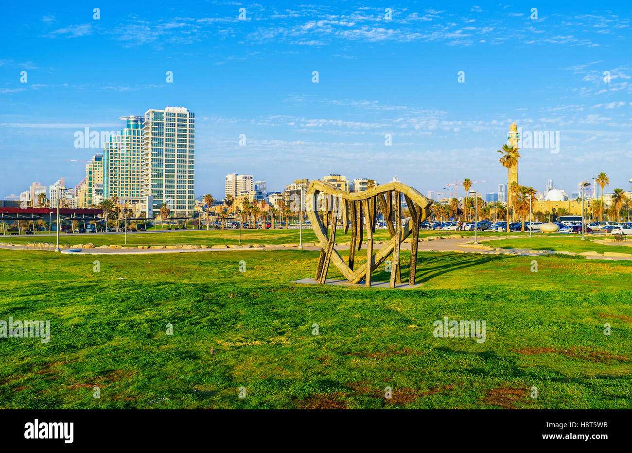 The stone heart installation in Charles Clore Park with the modern city ...