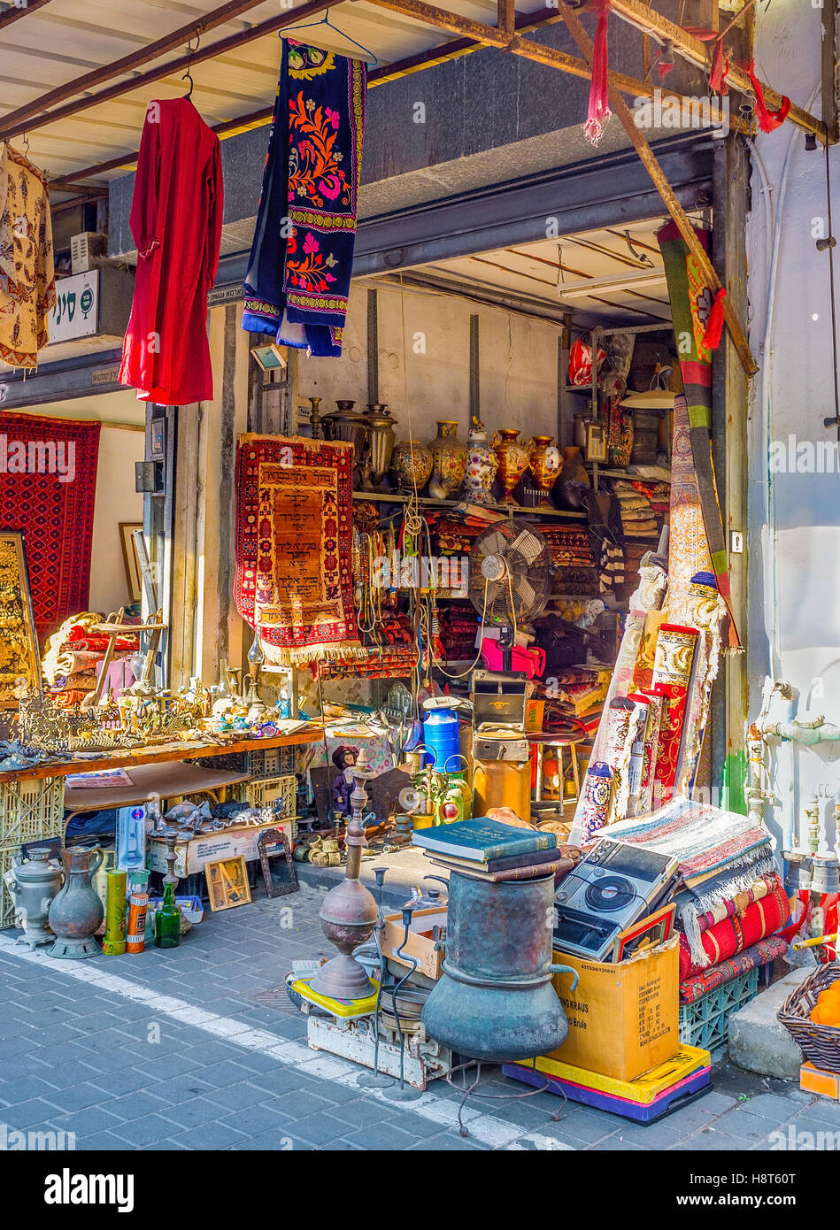 The market stall offers different goods, from the colorful carpets to ...