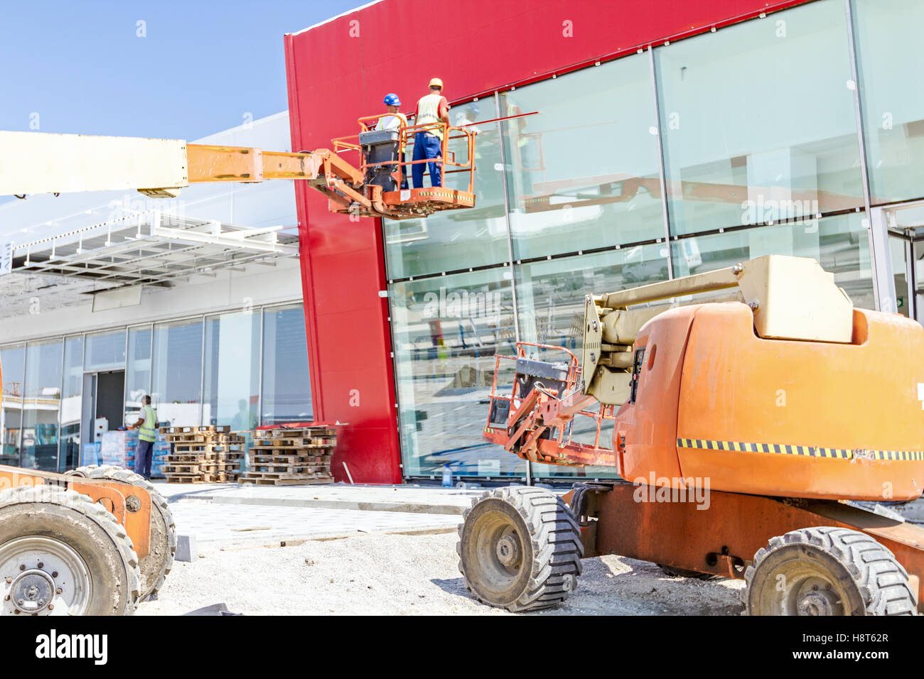 Cherry picker has elevated platform with riggers in safety basket at ...