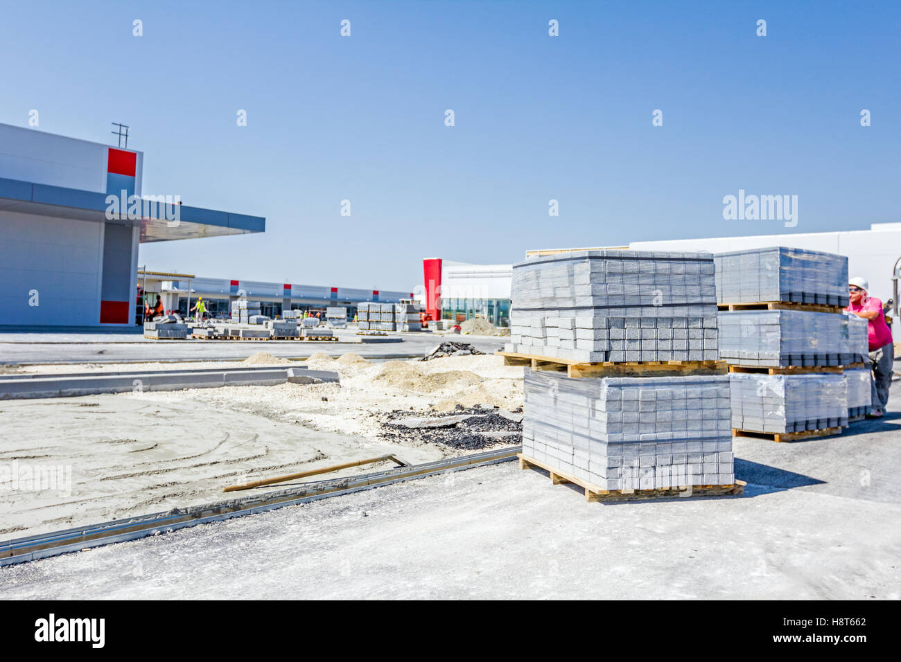 Wooden pallets with paving slabs are wrapped in plastic foil at ...