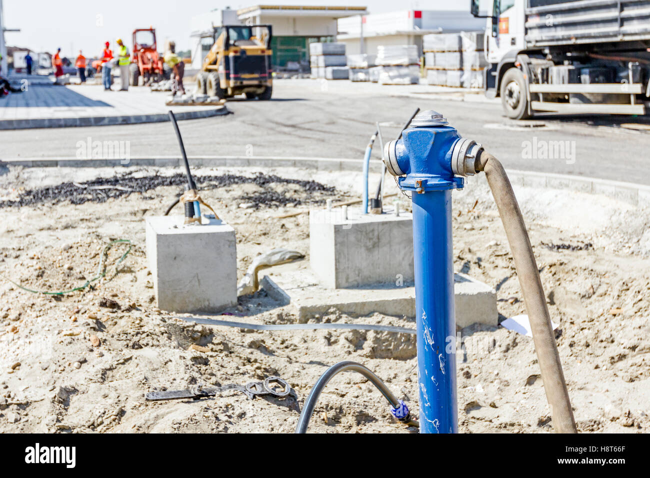 Water hose is attached to newly placed fire hydrant on construction ...