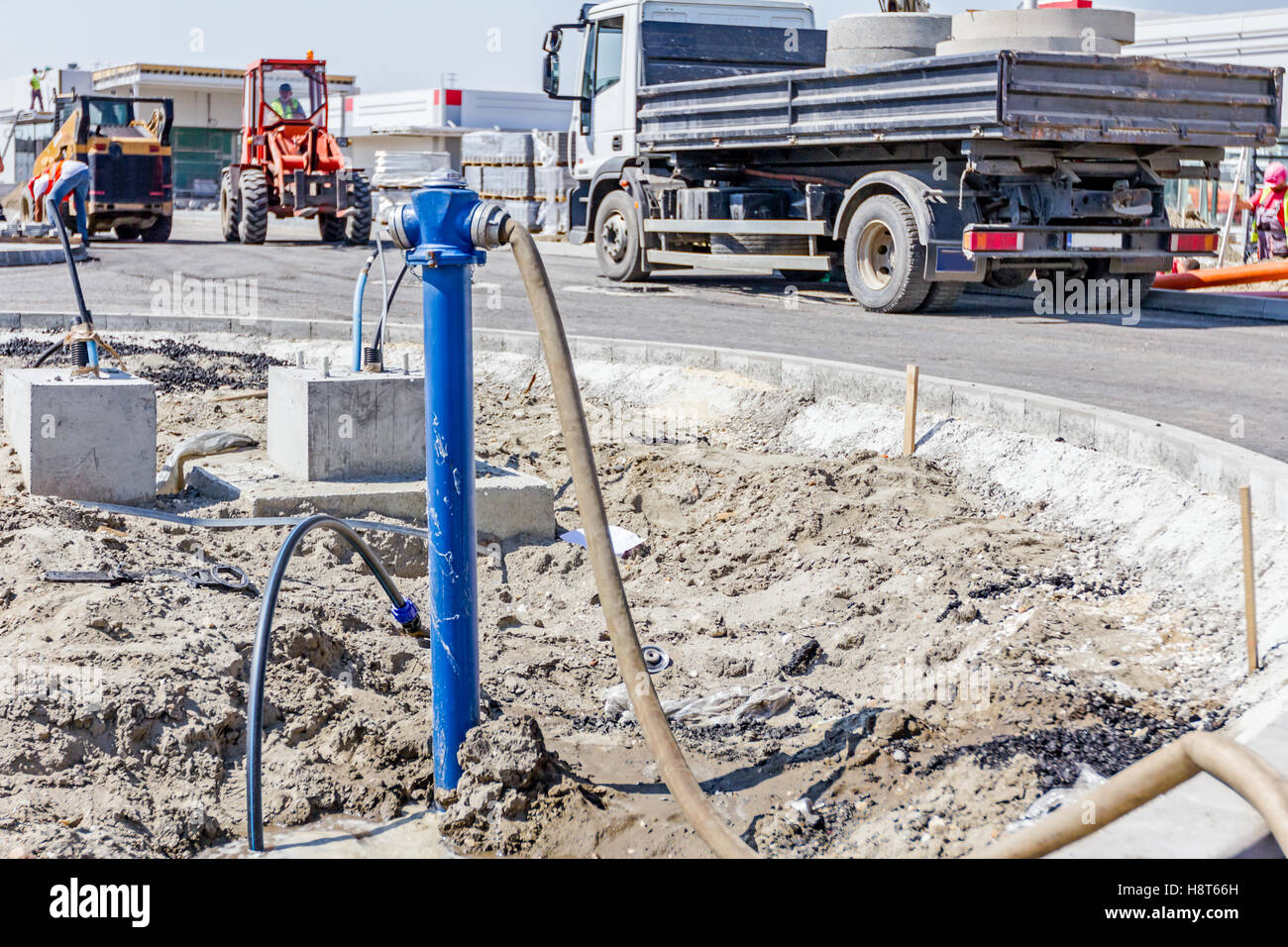 Water hose is attached to newly placed fire hydrant on construction ...