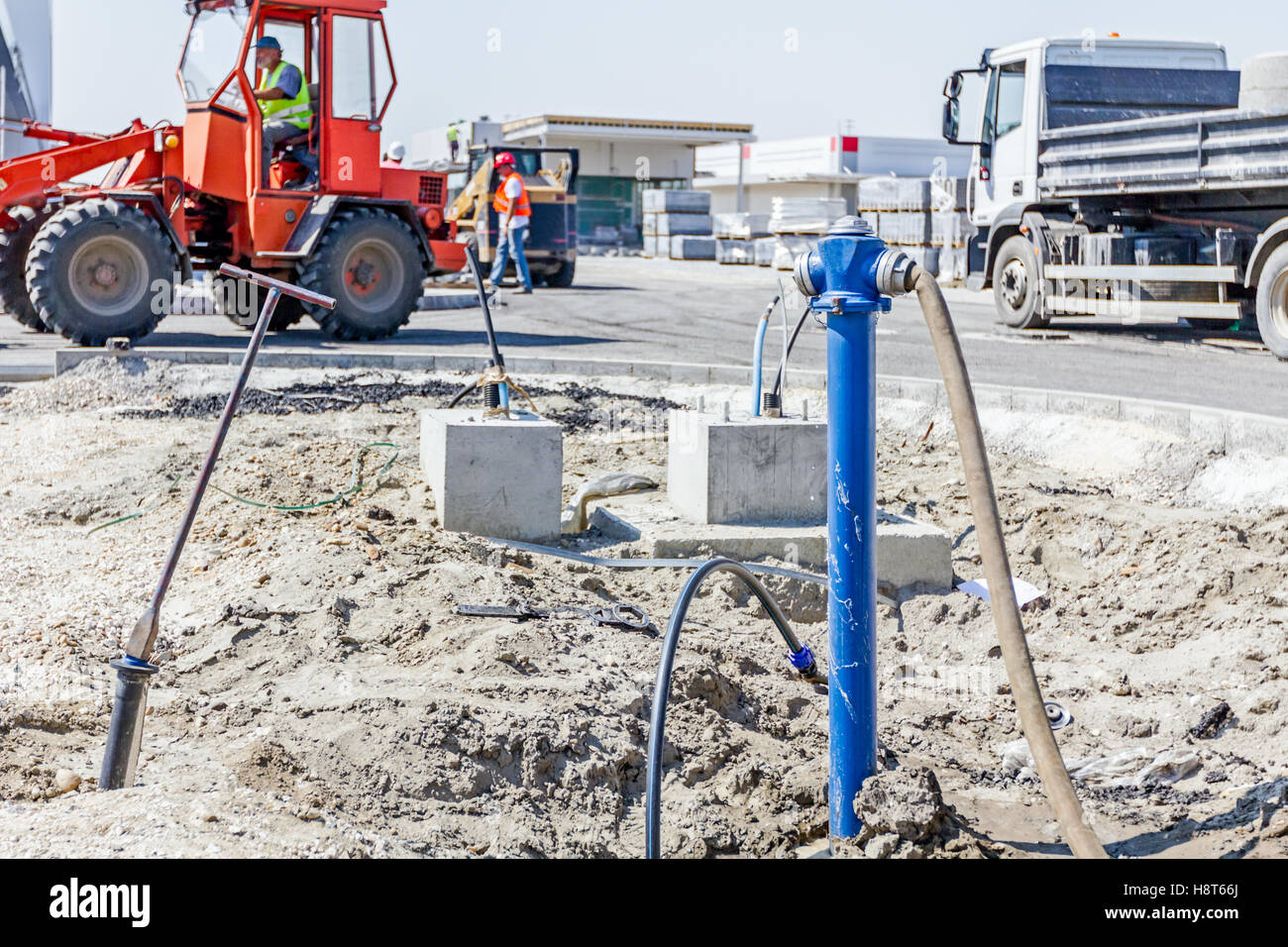 Water hose is attached to newly placed fire hydrant on construction ...