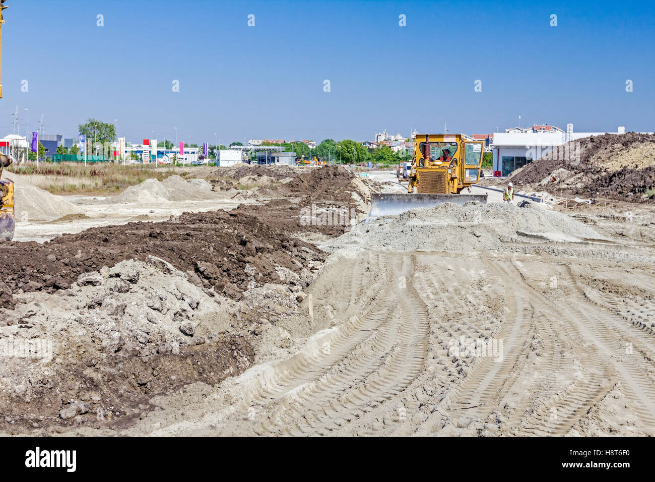 Earthmover with caterpillars is moving earth at building site Stock ...