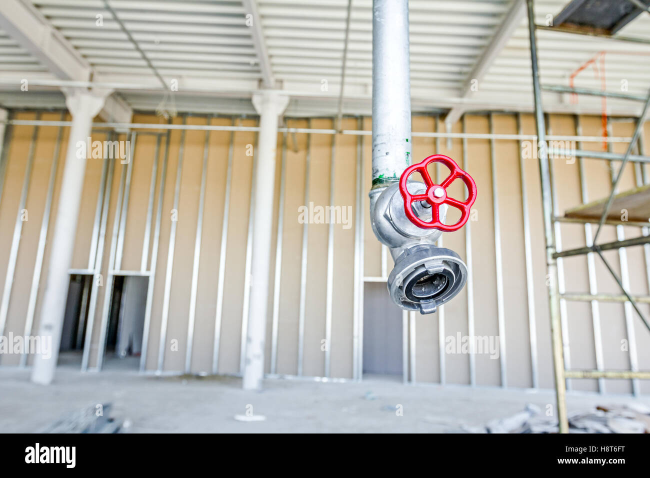 Red faucet from firefighter galvanized steel pipeline is hanging from ...