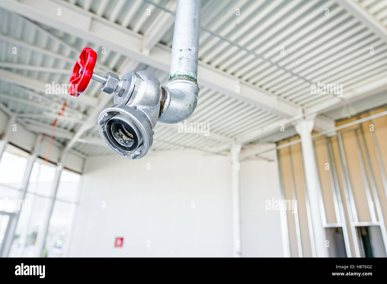 Red faucet from firefighter galvanized steel pipeline is hanging from ...