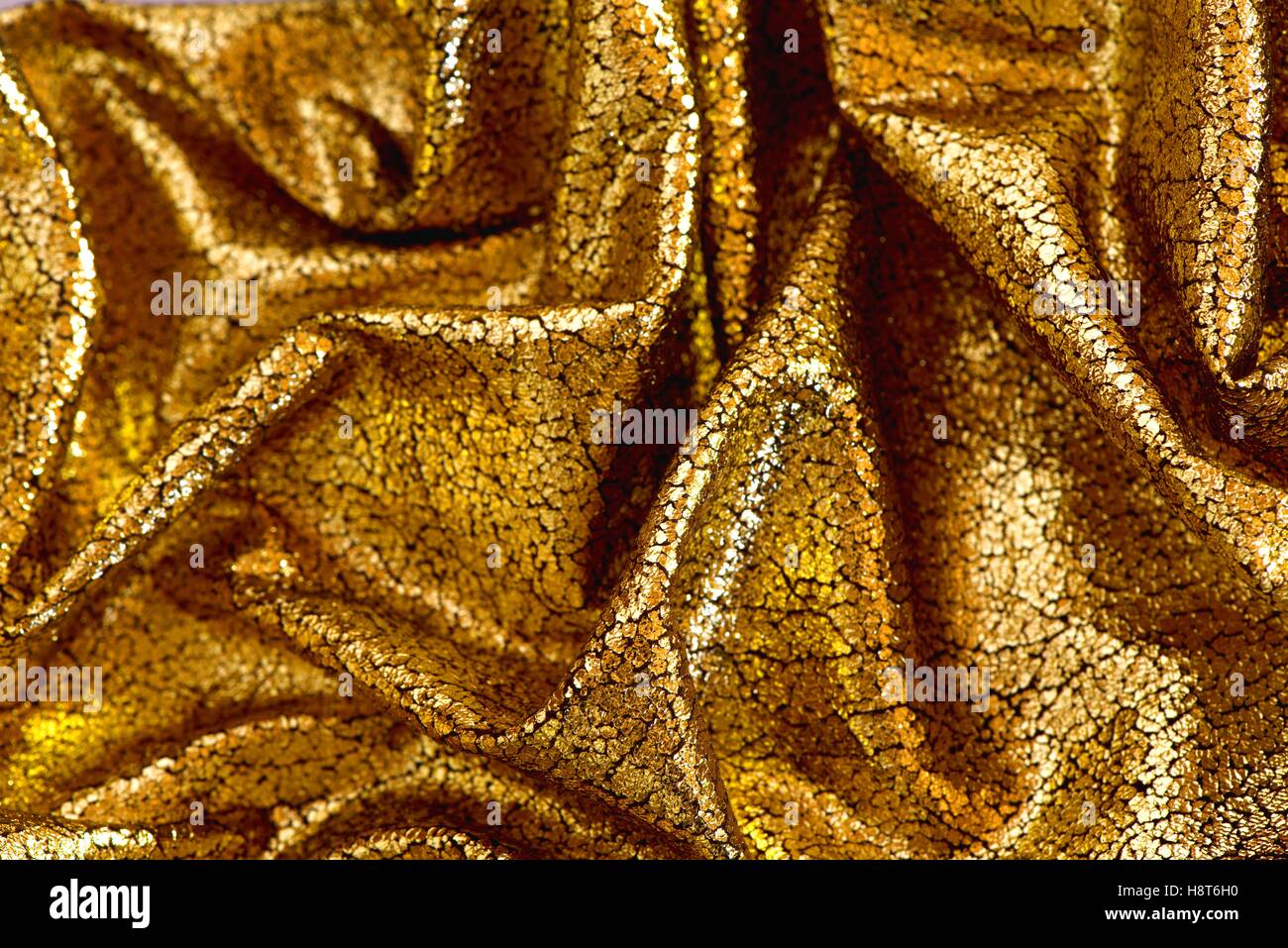 Folded golden Christmas cloth with cracks Stock Photo - Alamy