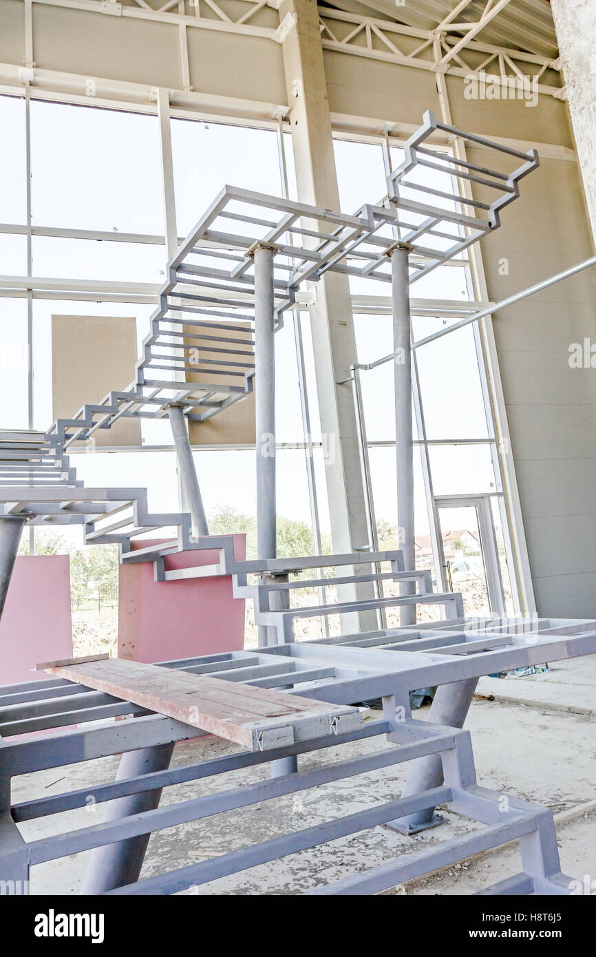 Partially assembled skeleton of crisscross stairs leading up, work in ...