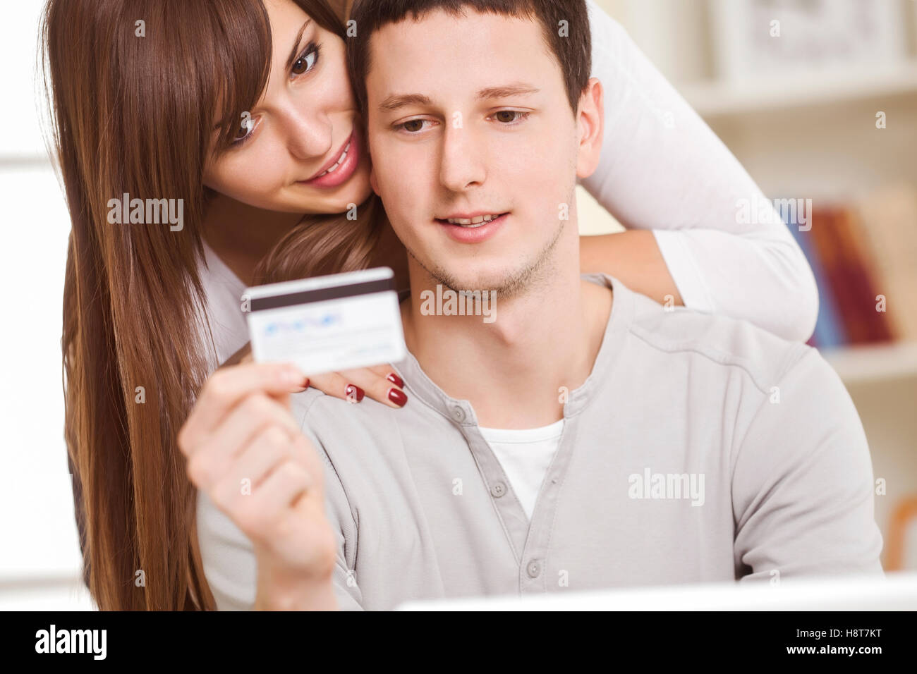 Portrait of a happy couple using laptop for banking transactions Stock ...